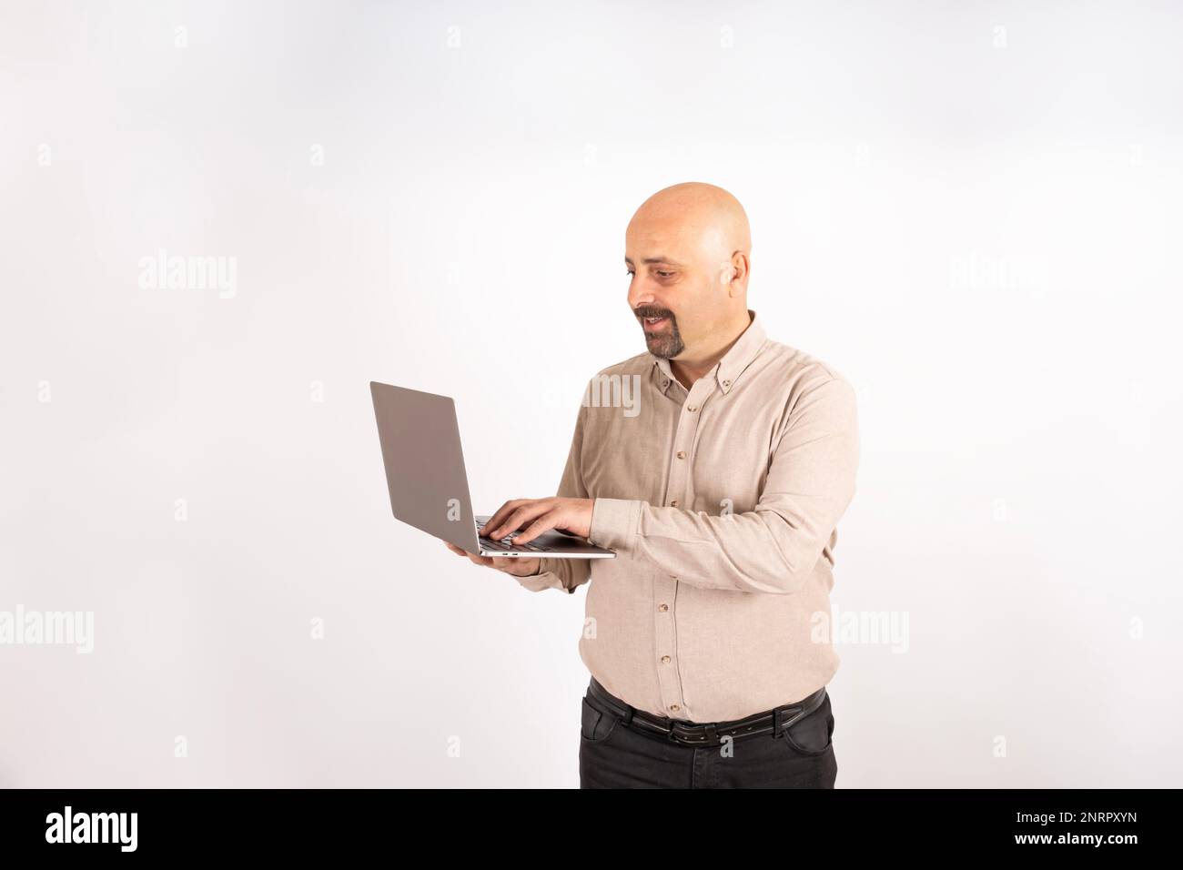 Man holding laptop working online. Standing over isolated light gray ...