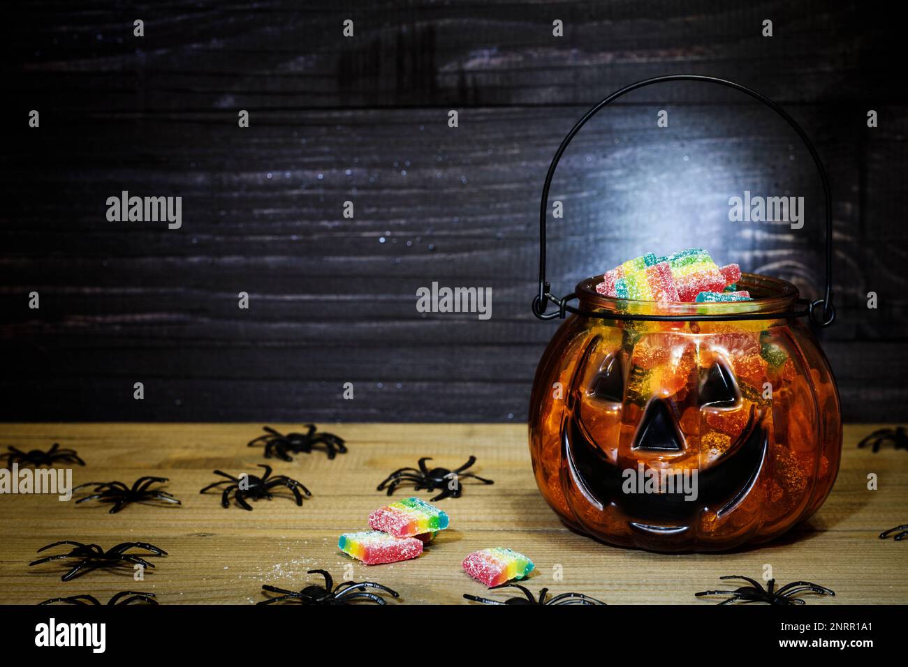 Pumpkin with candy near spiders on wood background for halloween party ...