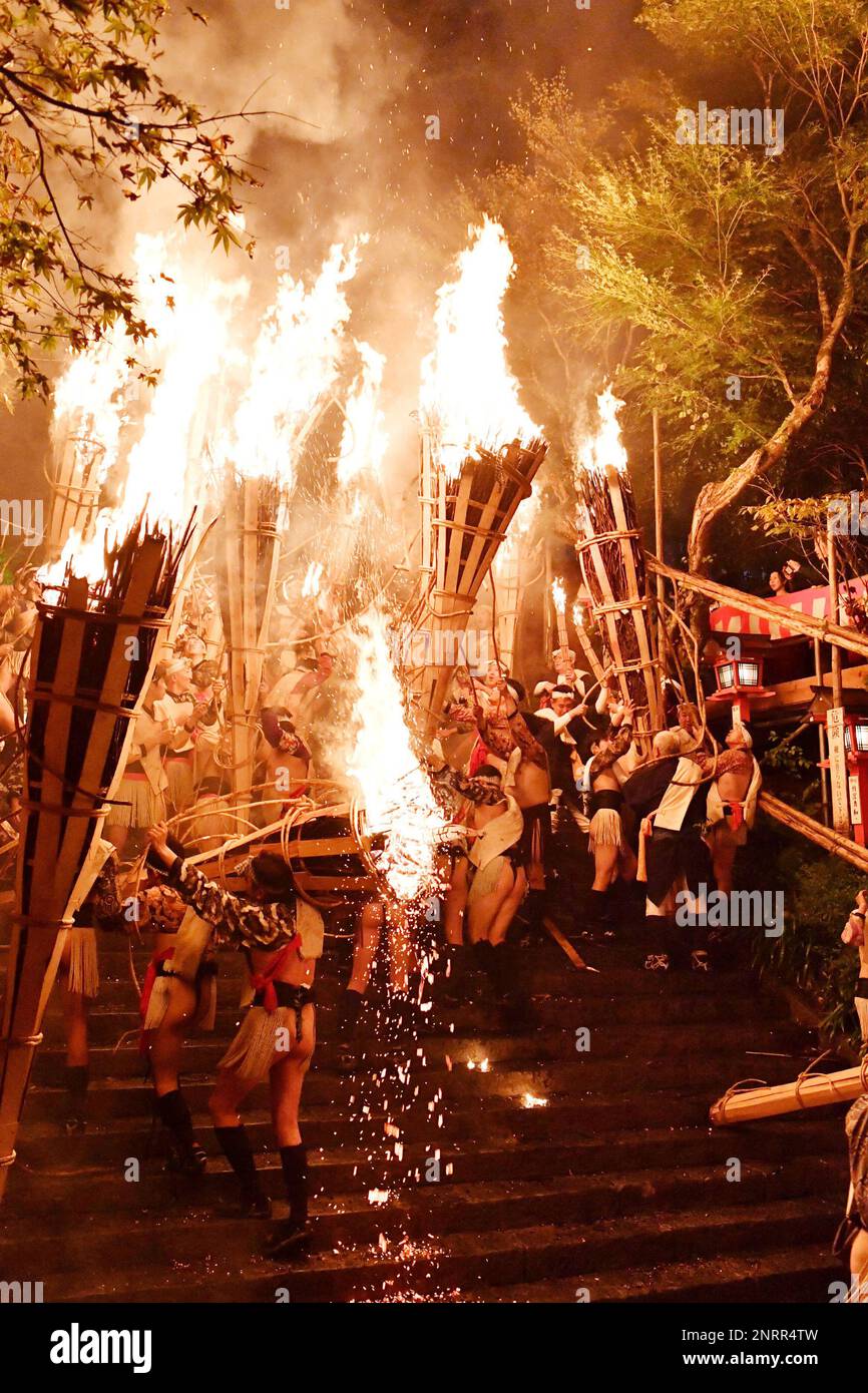 Participants holding torches march around the Yuki Jinja shrine during ...