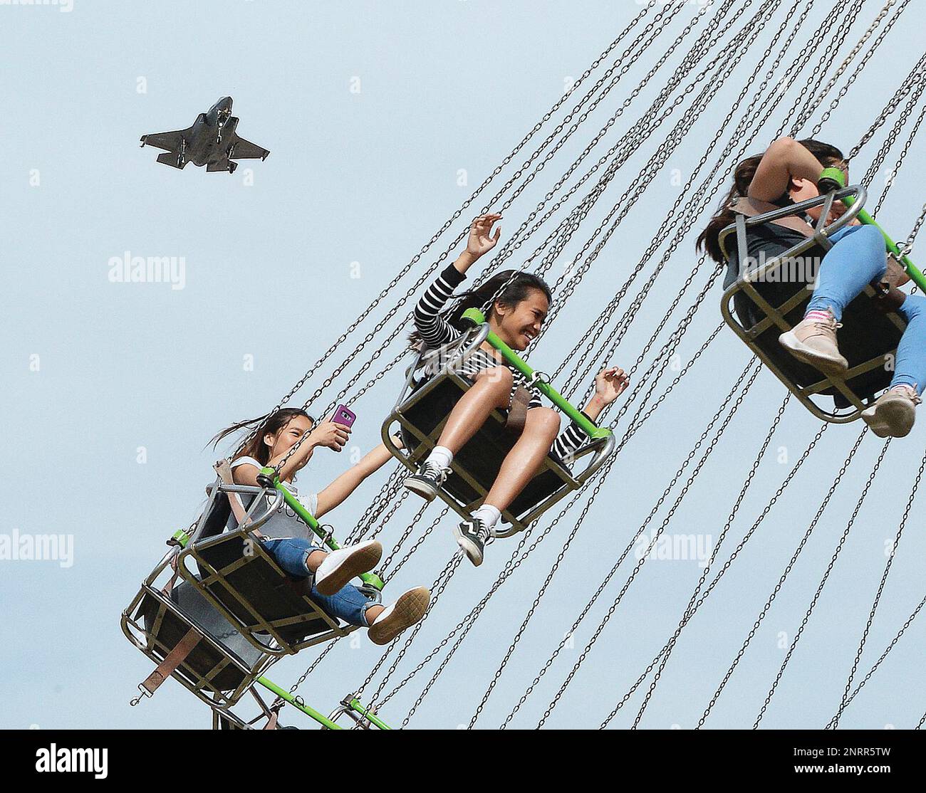 Fairgoers ride the "Yo Yo" swings on the midway at the 67th annual Yuma ...