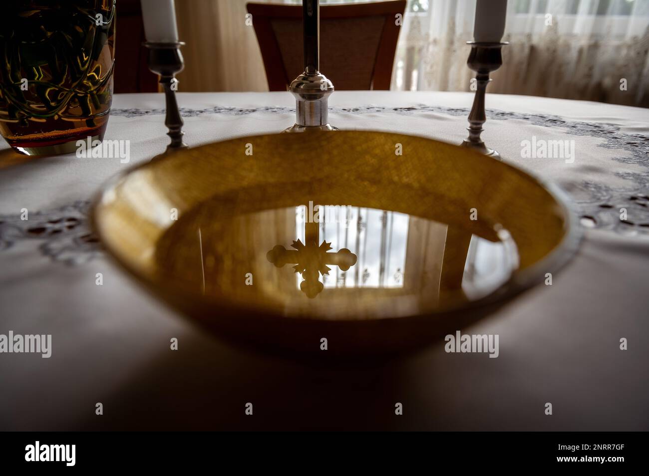 sprinkler and holy water on a wedding blessing crucifix reflected on ...