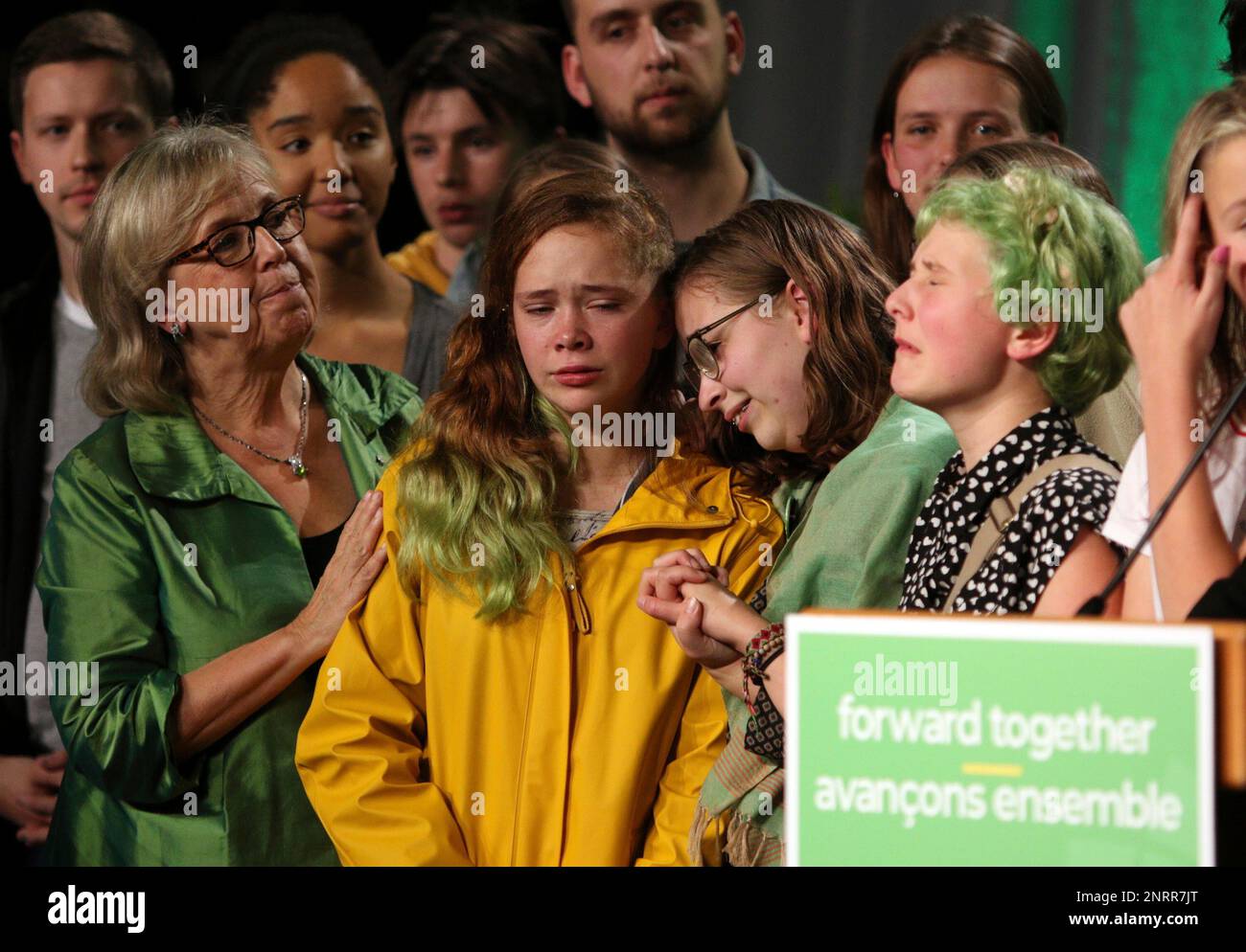 Green Party leader Elizabeth May looks on as young supporters from left ...