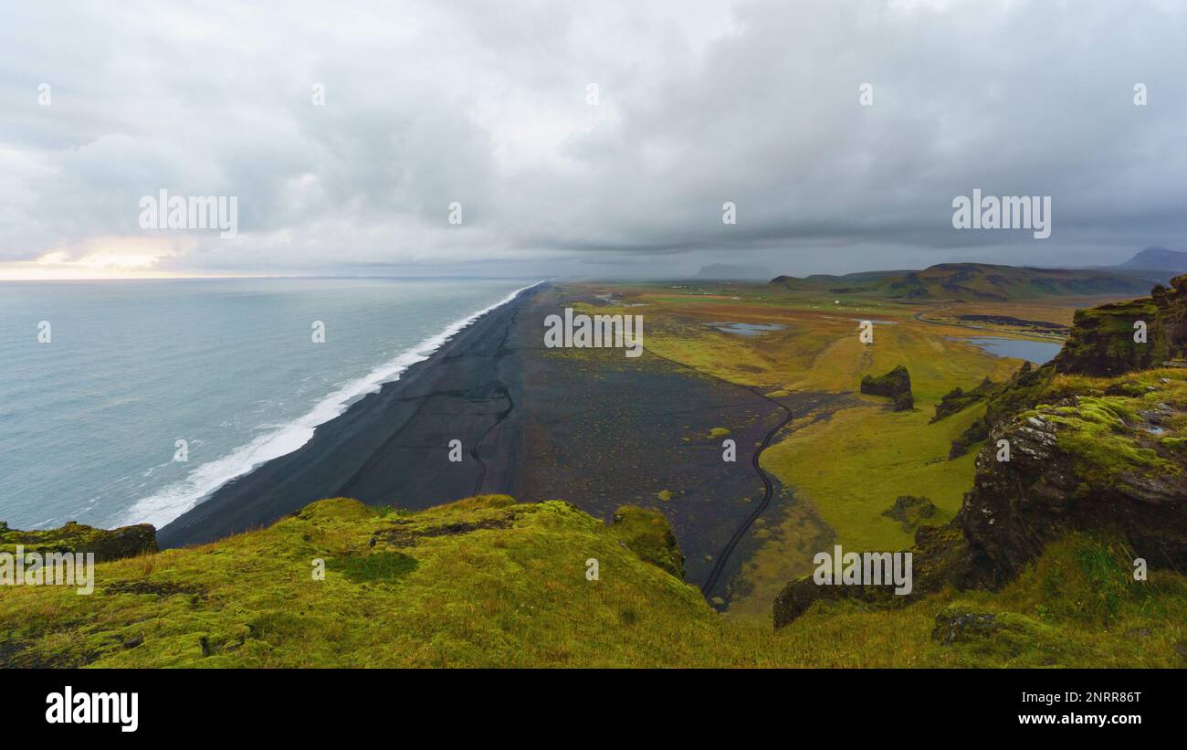 Southern Iceland, Vik. View on sea, green valley and black sands beach ...