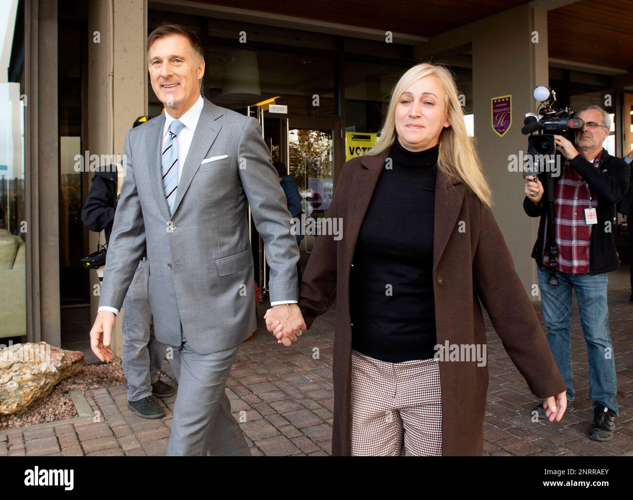 People's Party of Canada Leader Maxime Bernier walks out of a polling ...