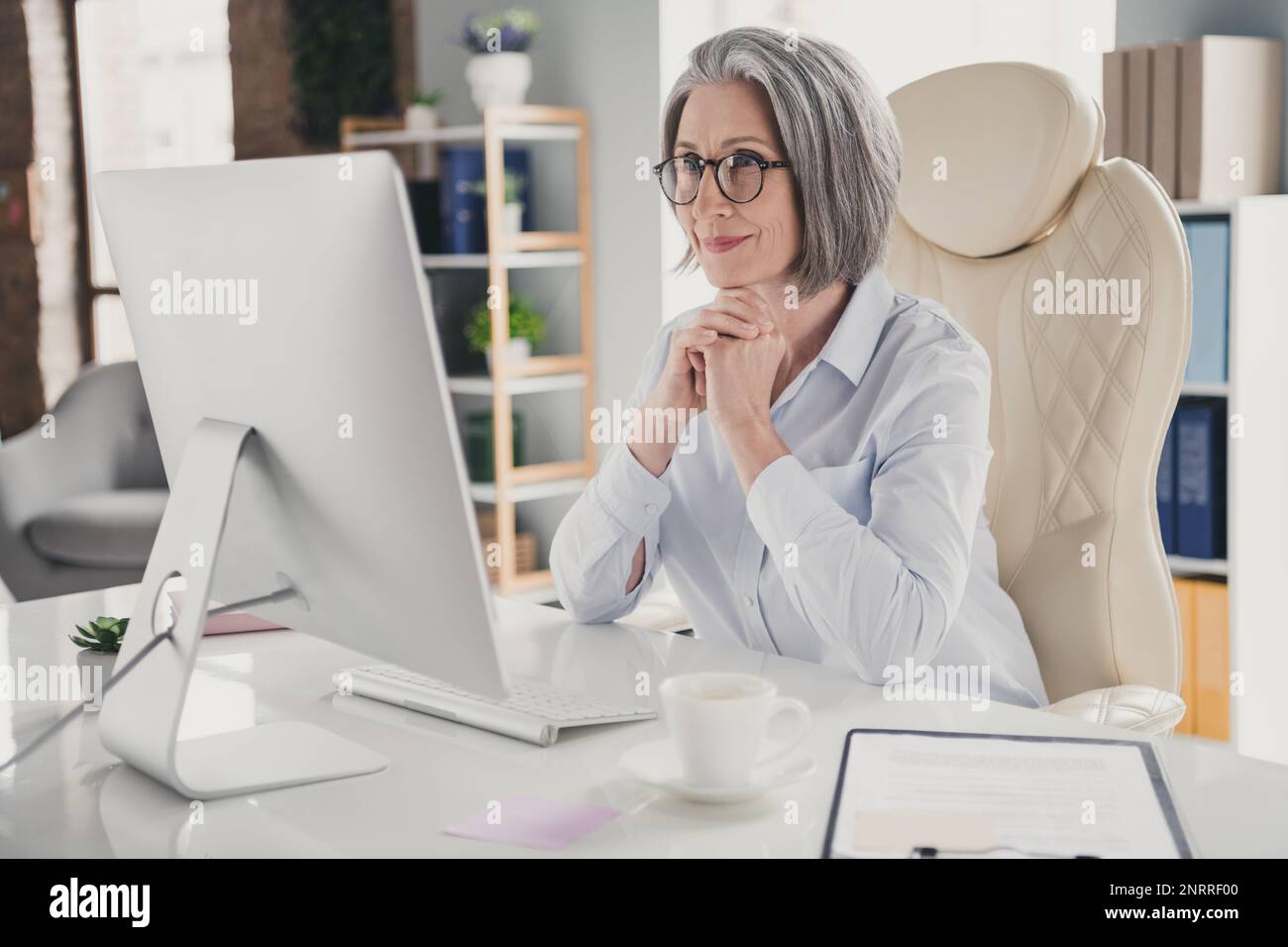 Photo of successful company owner sitting chair watch webinar video ...