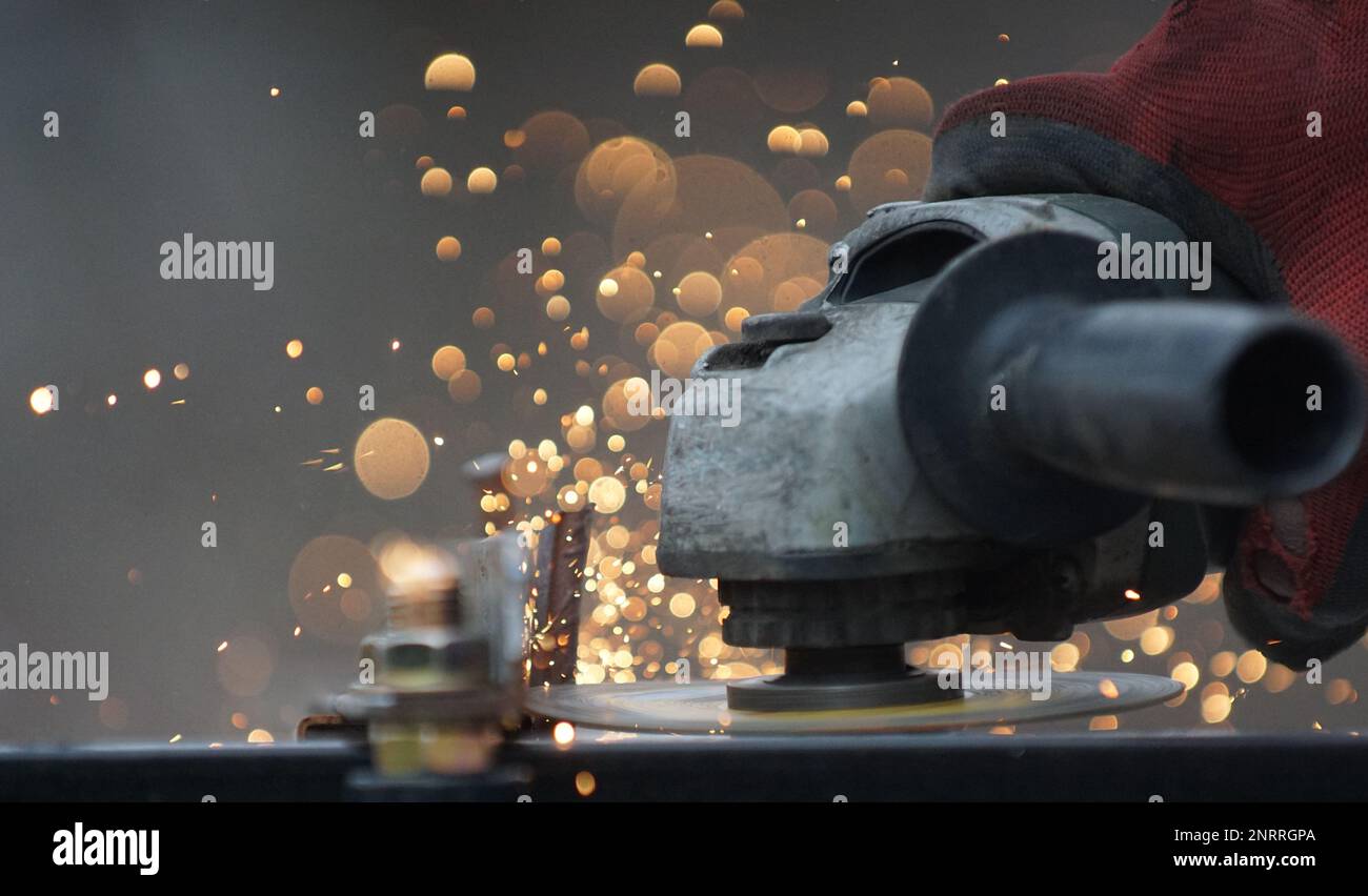 Metal processing with grinder. cutting metal on location of ...