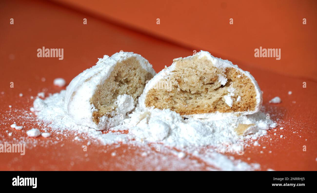 vanilla cookies crackers with sugar powder on orange background, sweet ...