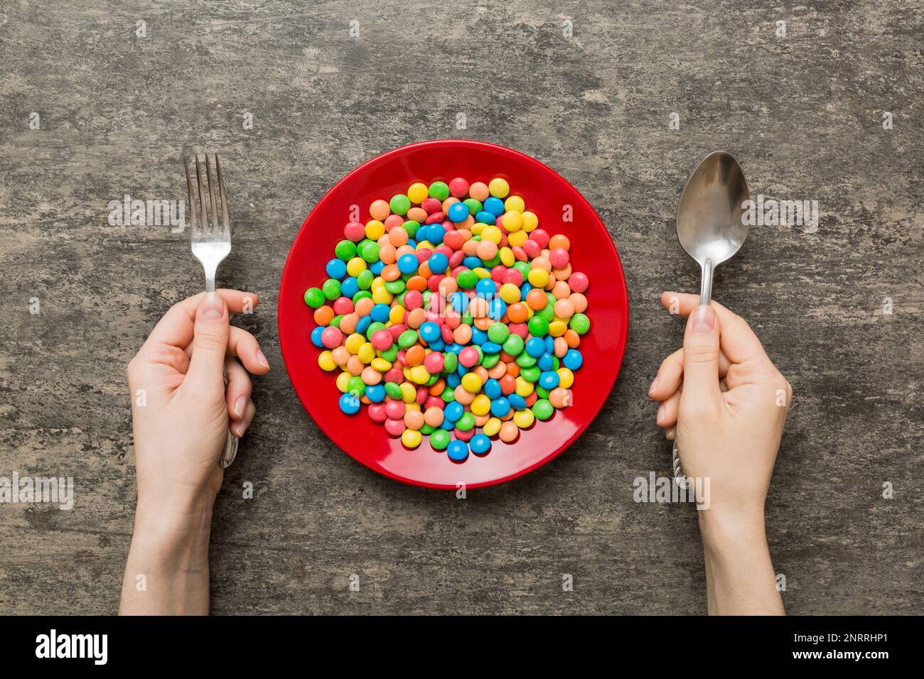 the girl holds cutlery in her hands and eats sweets in a plate. Health ...