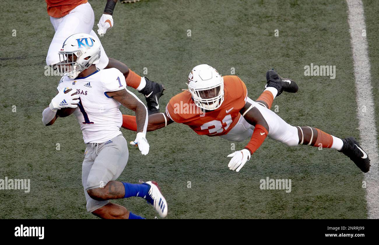 Texas defensive back DeMarvion Overshown (31) leaps to tackle Kansas ...