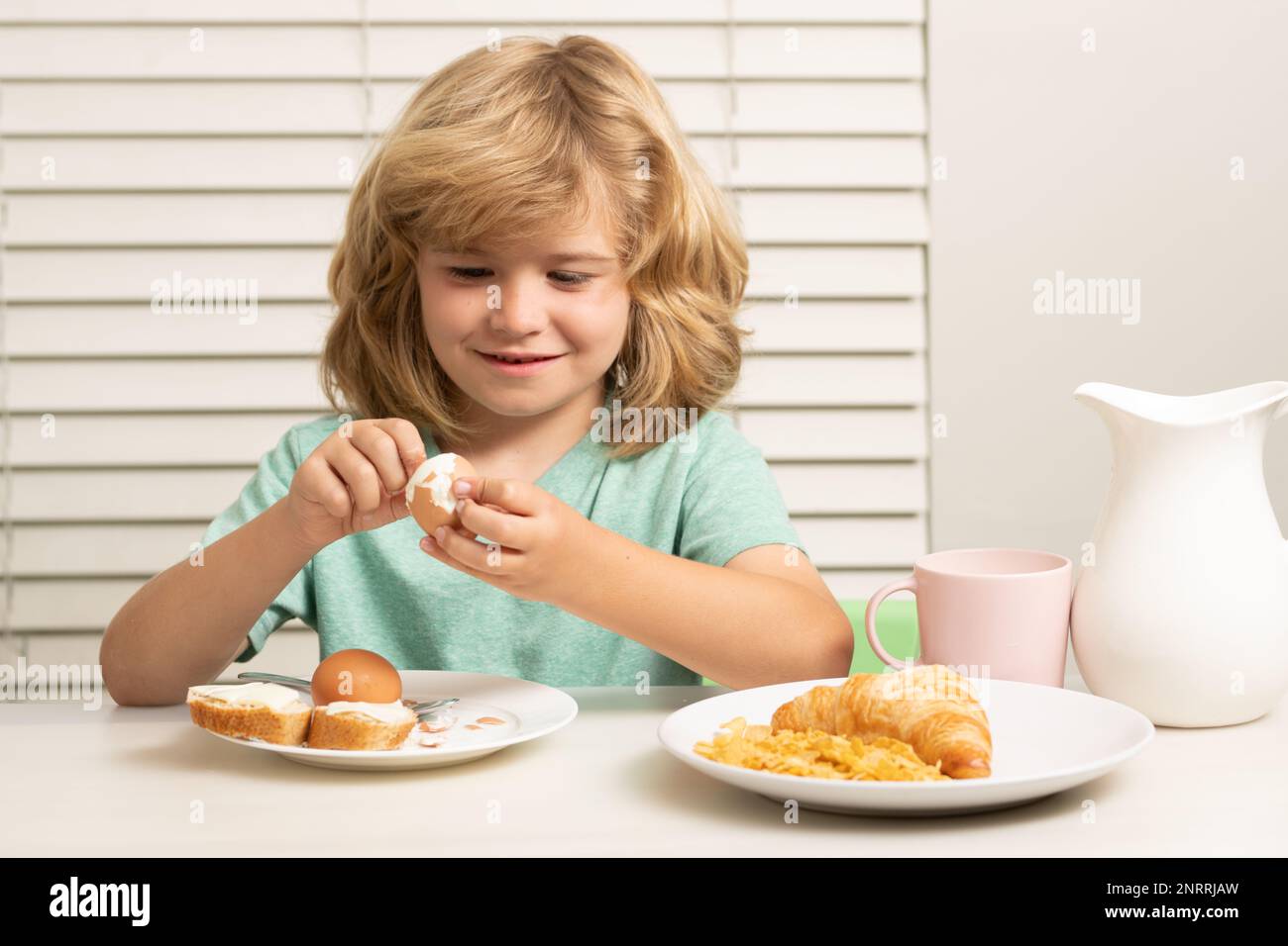 Kid eating egg. Portrait of preteen child eat fresh healthy food in ...