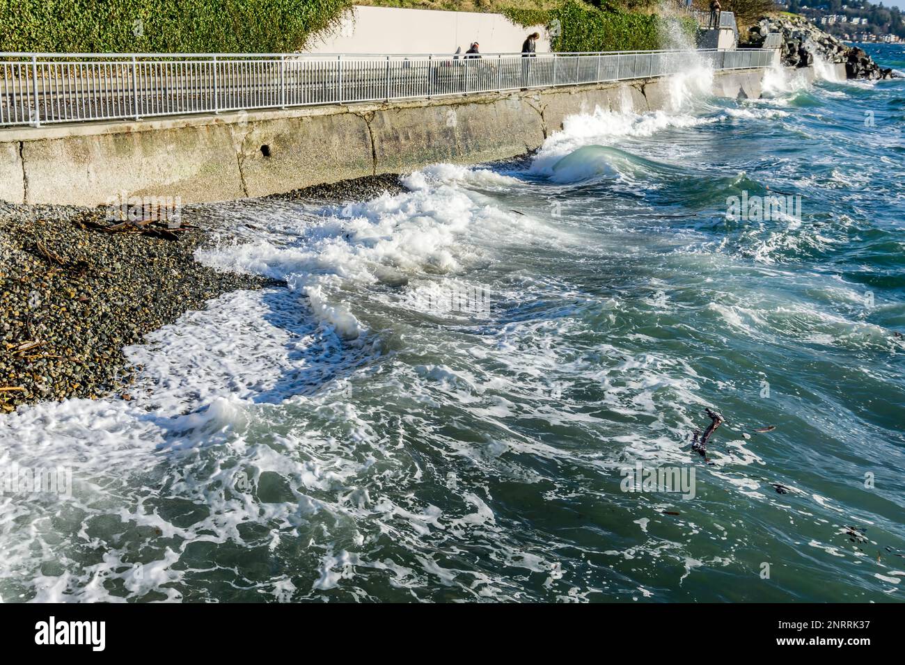 Wind blows waves into the sea wall in West Seattle, Washington Stock ...
