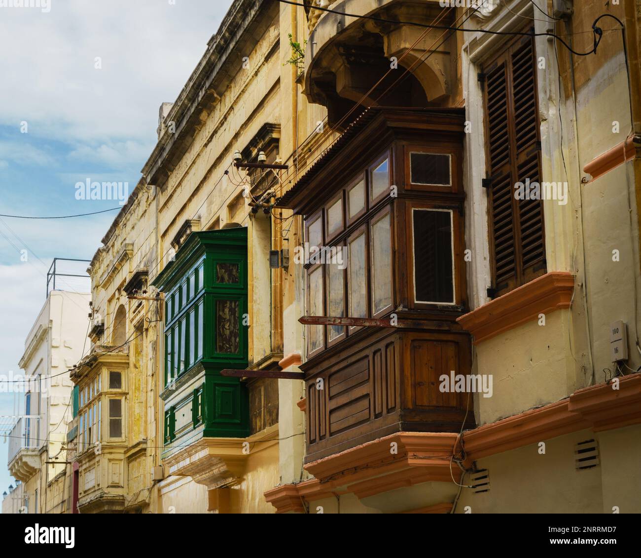 Brown, green, yellow colorful traditional maltese balconies yellow ...