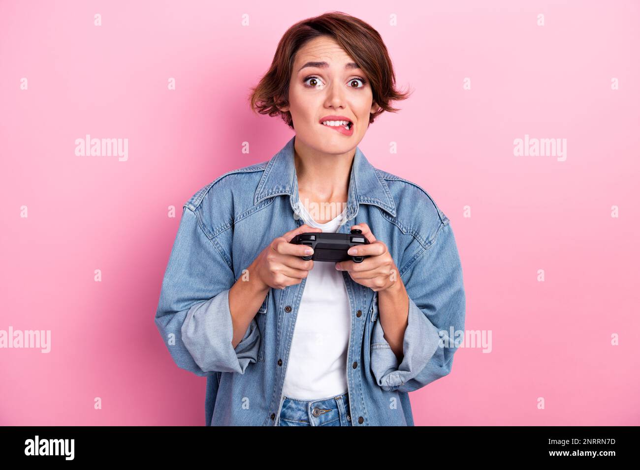 Photo of doubtful unsure lady dressed denim jacket loosing playstation ...