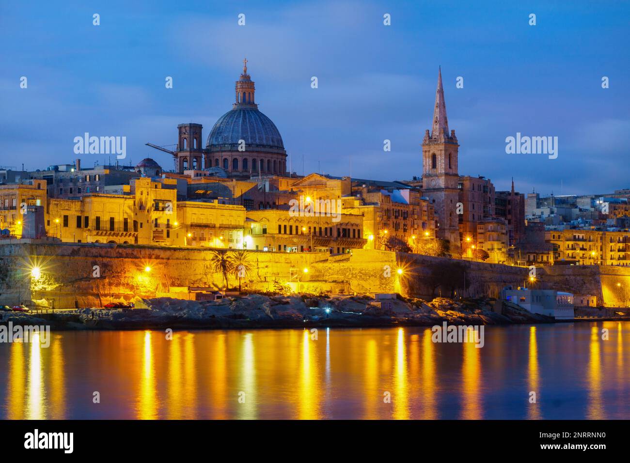 Night view of Valletta, capital of Malta. Beautiful spires and St ...