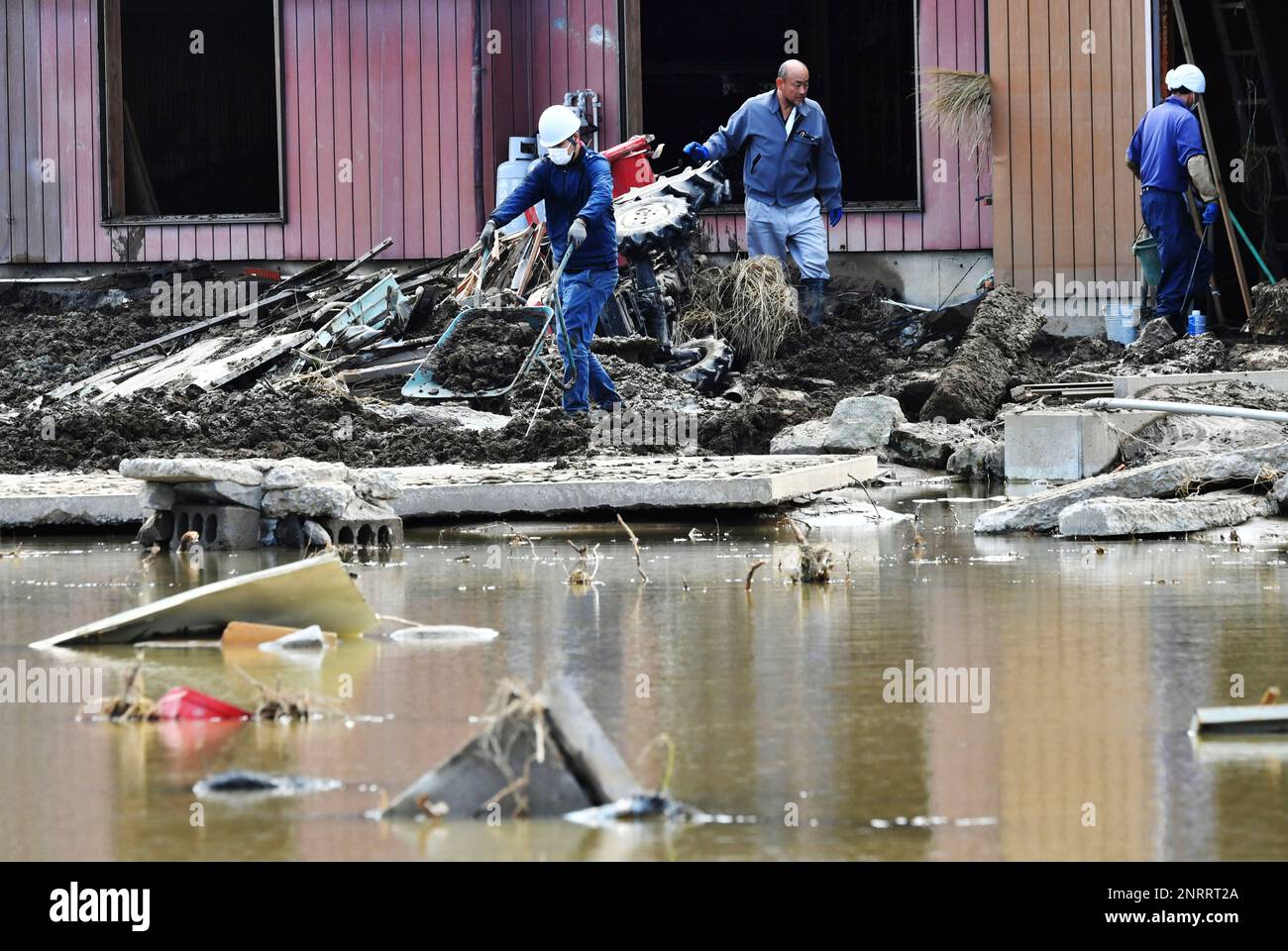 The suffers clean a house which was flooded in Nagano City, Nagano ...