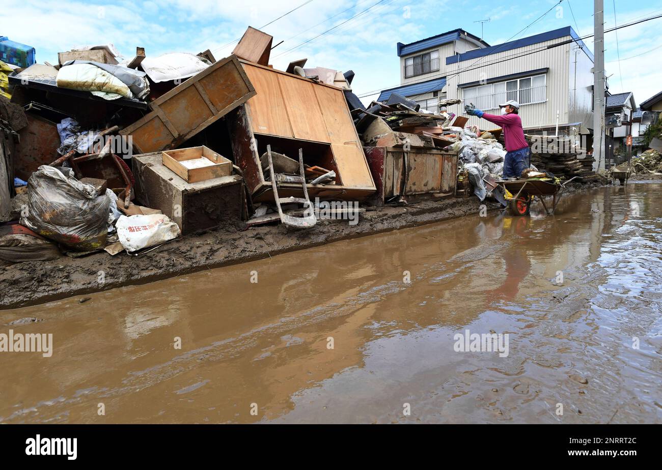The suffers throw away garbage after the flood in Nagano City, Nagano ...