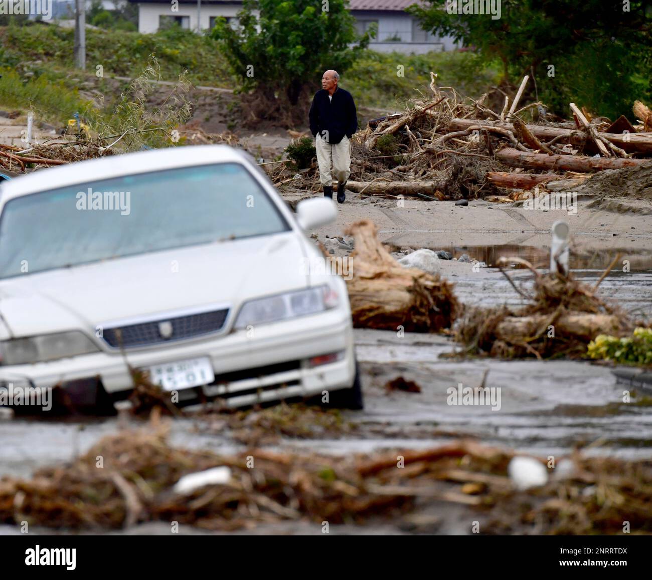 A resident walks around disaster stricken area in Marumori, Miyagi ...