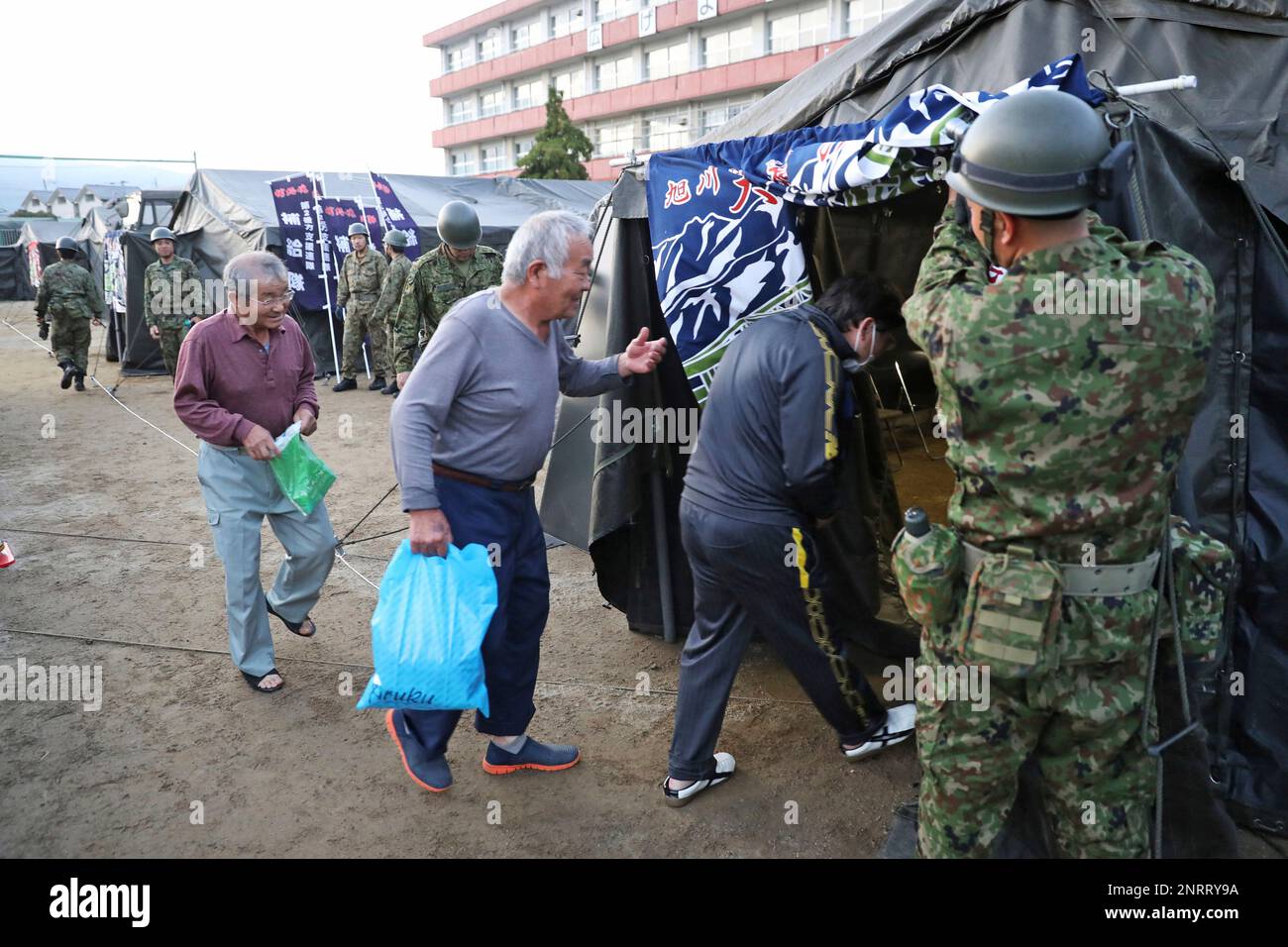 Disaster victims take a bath which was set by the Self-Defense Forces ...