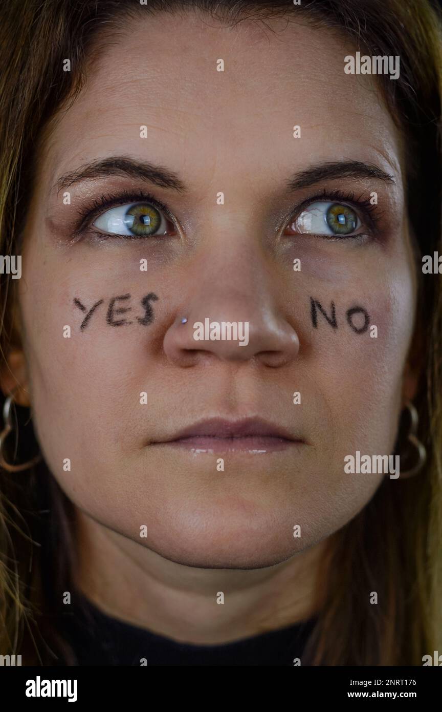 making decisions - portrait of a beautiful blonde woman with yes and no ...