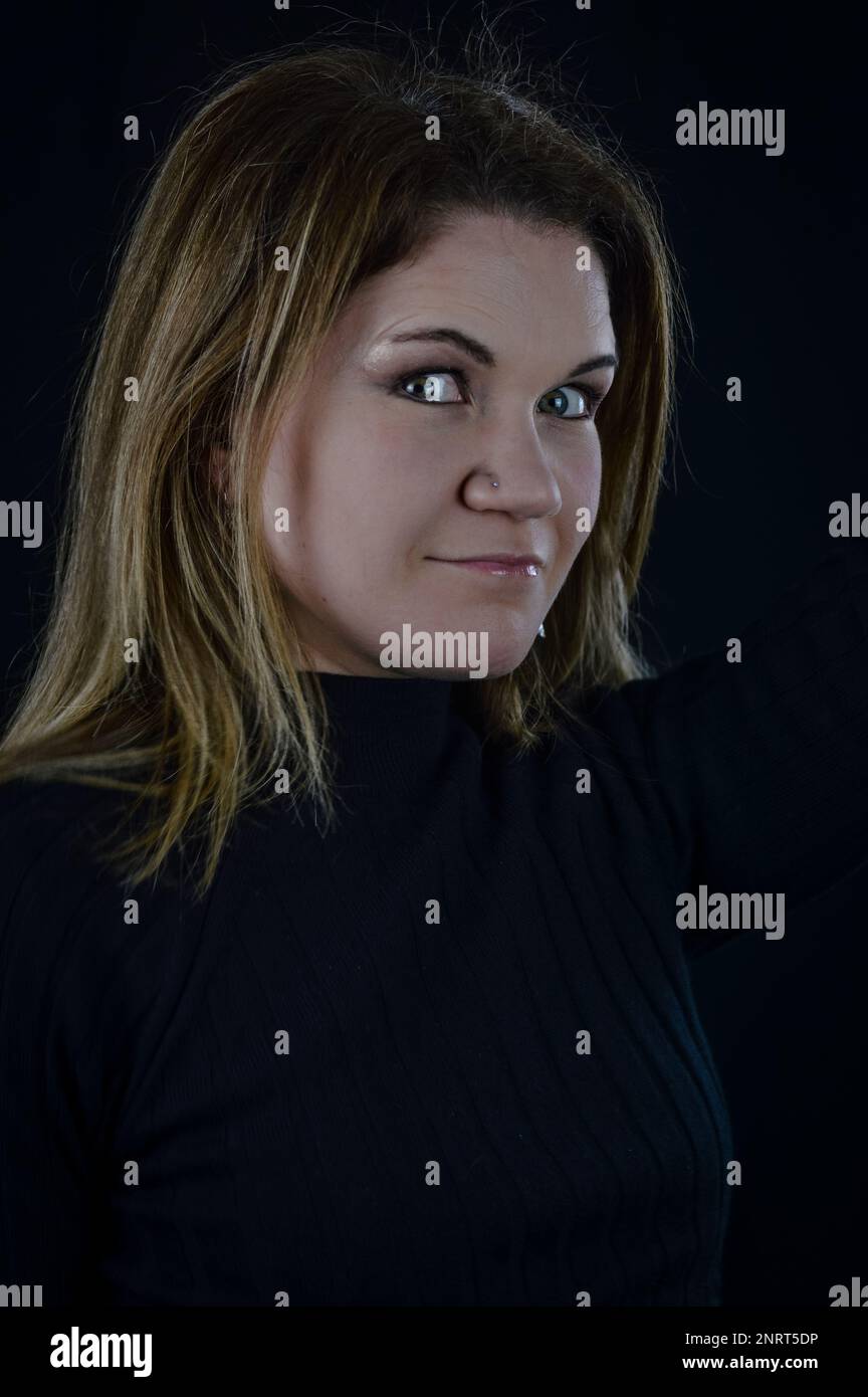 portrait of a beautiful blond woman with her eyes wide open and a ...