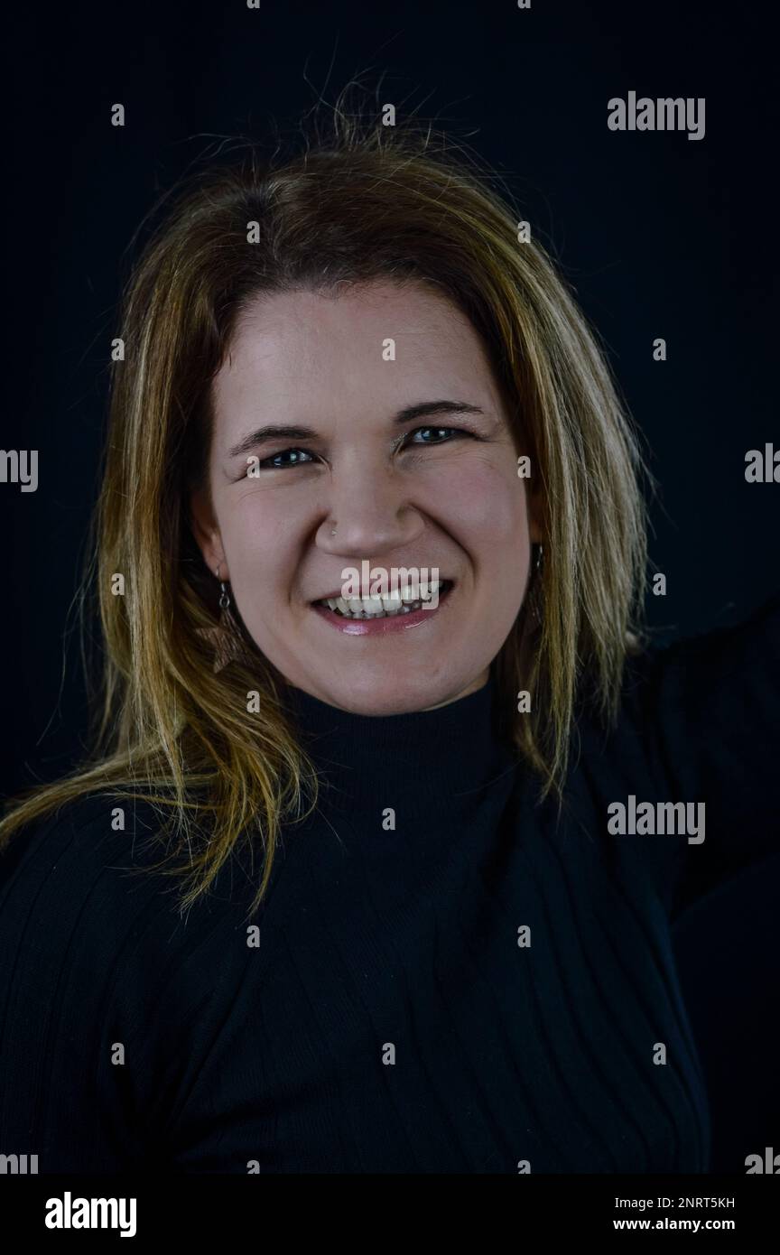 portrait of a beautiful blonde woman laughing cheerfully spontaneously ...