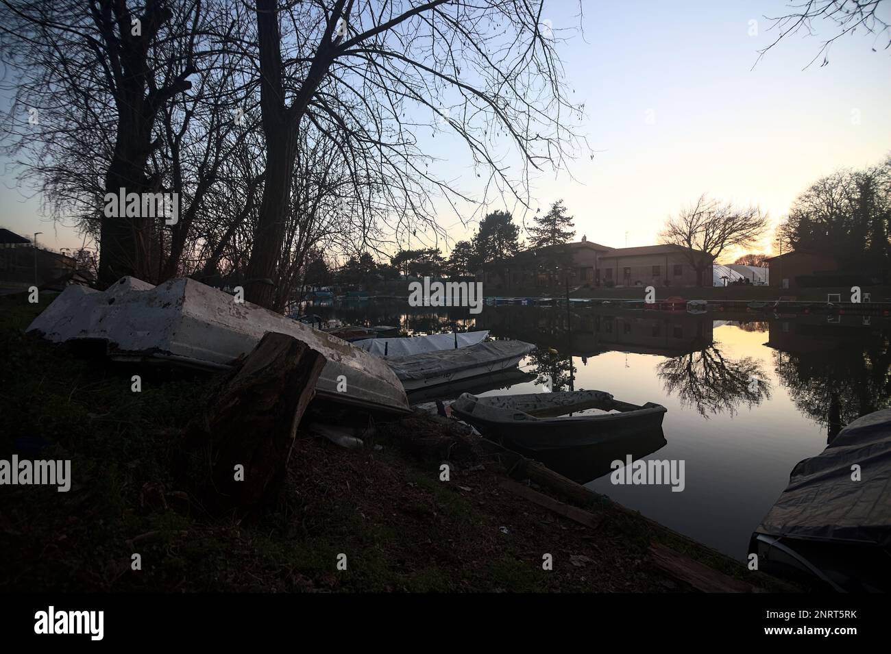Pier in an inlet at sunset Stock Photo - Alamy