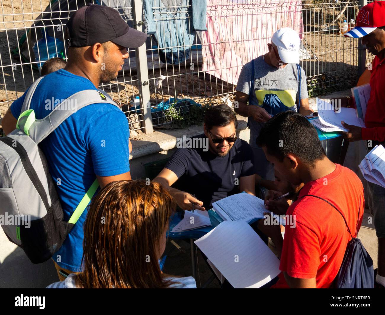 Volunteer Abraham Villarreal leafs through an asylum applicant's ...