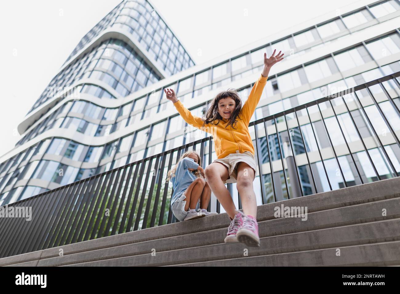 Two children jumping from hi-res stock photography and images - Alamy
