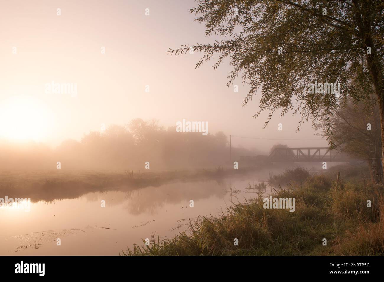 The Waveney river at Mendham, Suffolk, UK, on a misty autumn morning ...