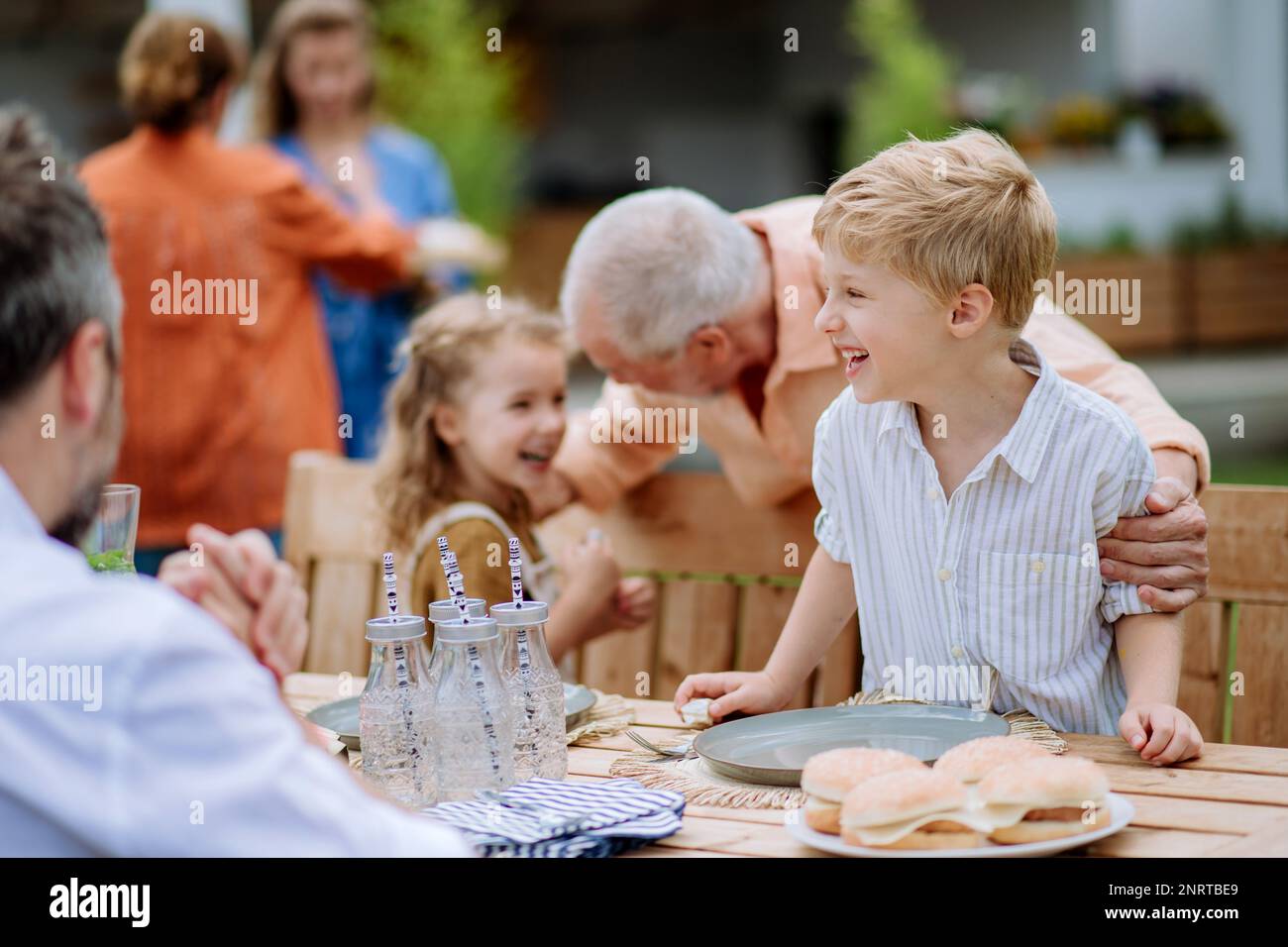 Multi generation family having outdoor garden party Stock Photo - Alamy