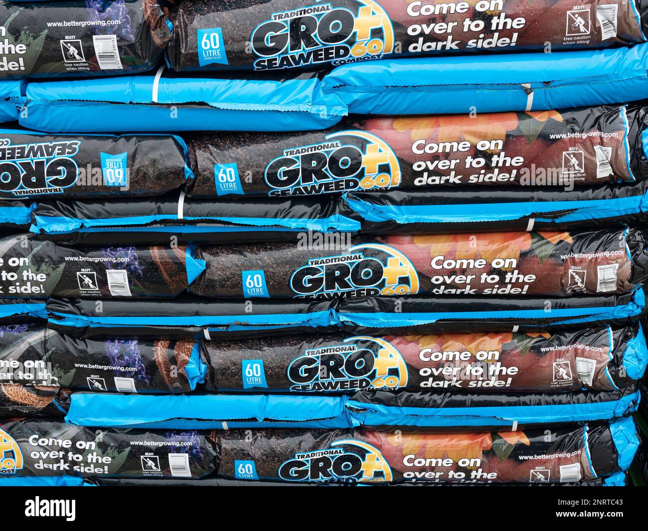 A stack of bags of Growmore Seaweed Compost in a farm shop in North ...