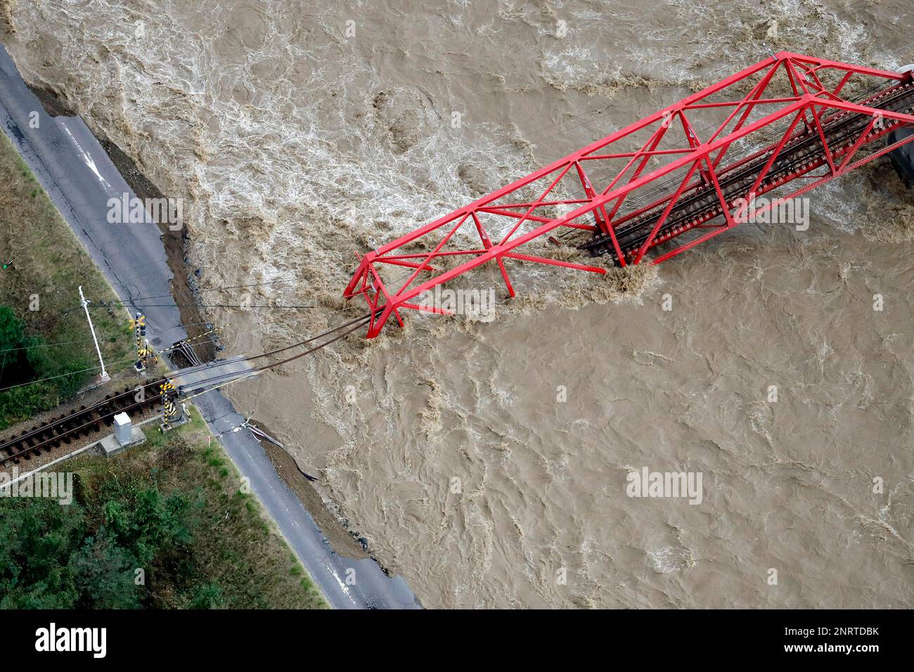 A collapsed railway bridge is seen over the Chikuma river swollen by ...