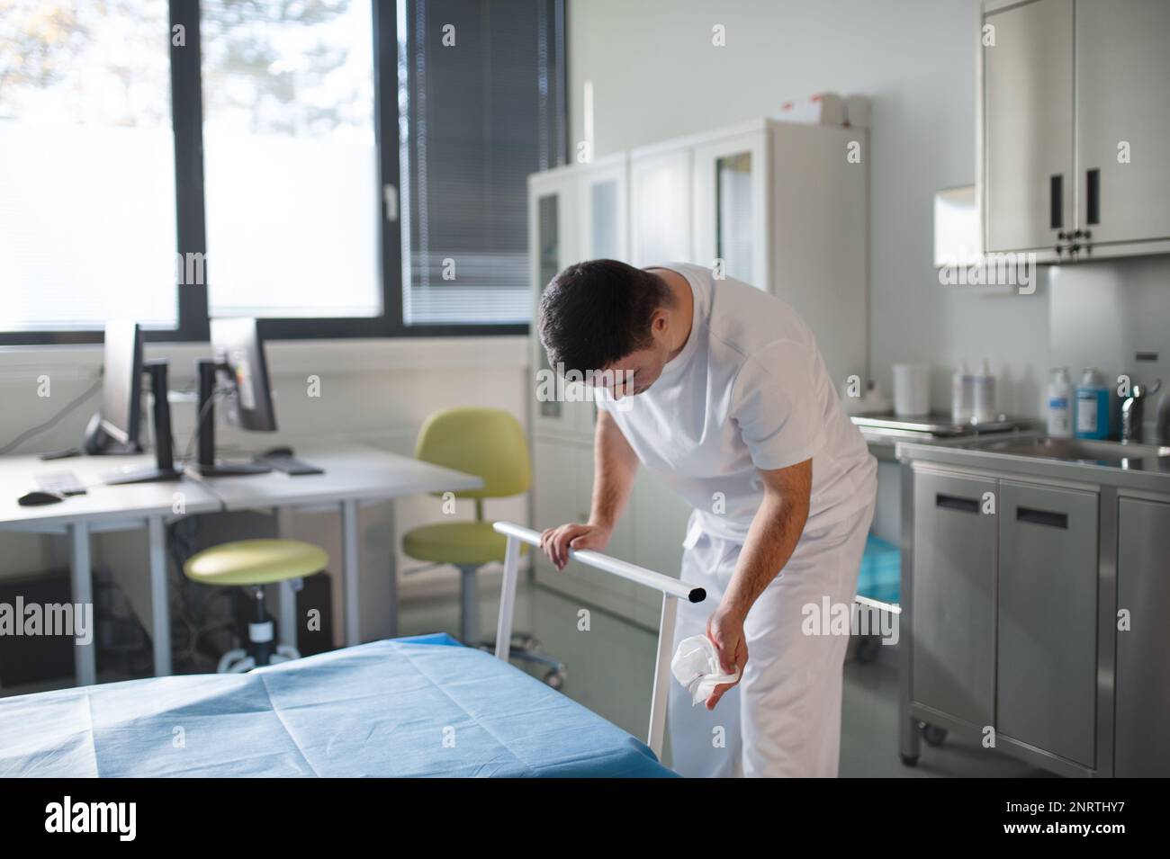 Young man with down syndome working in hospital as helper, cleaner ...