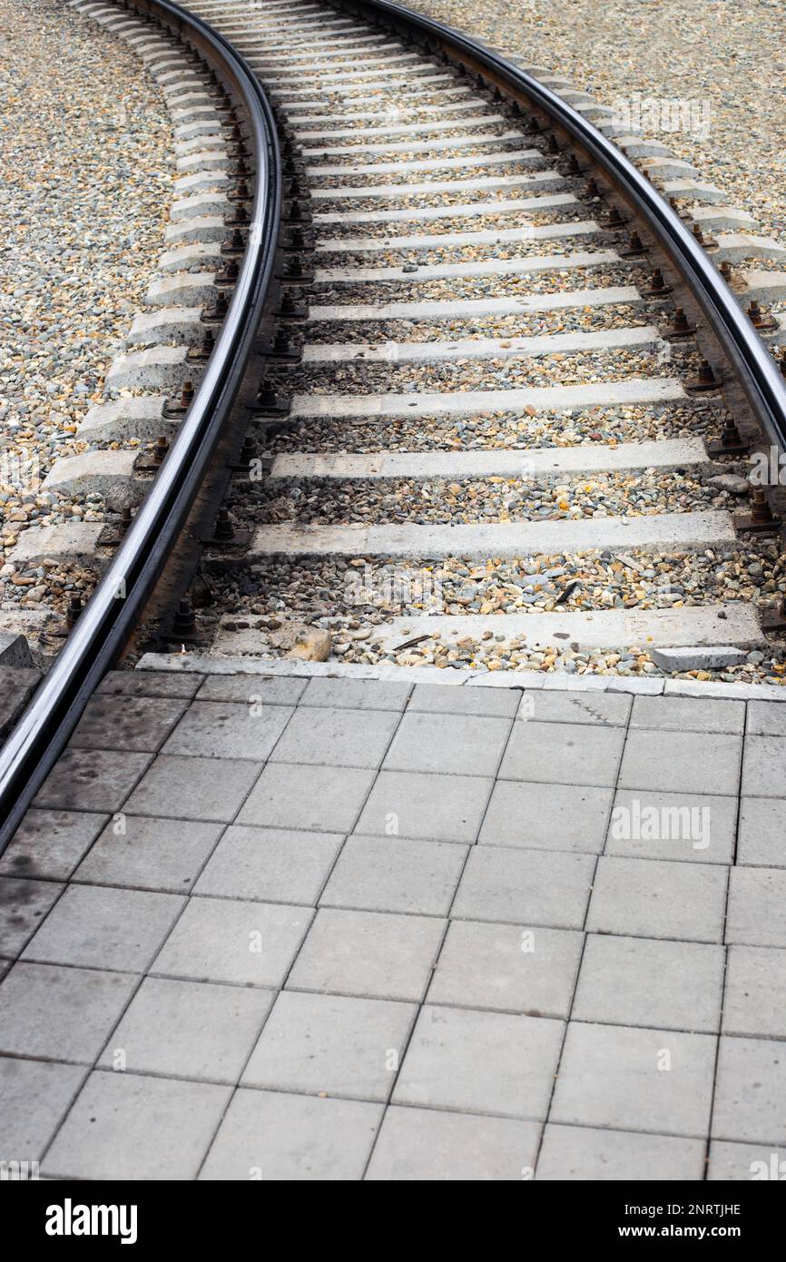Streetcar line with a platform for pedestrians to cross. The rails go ...