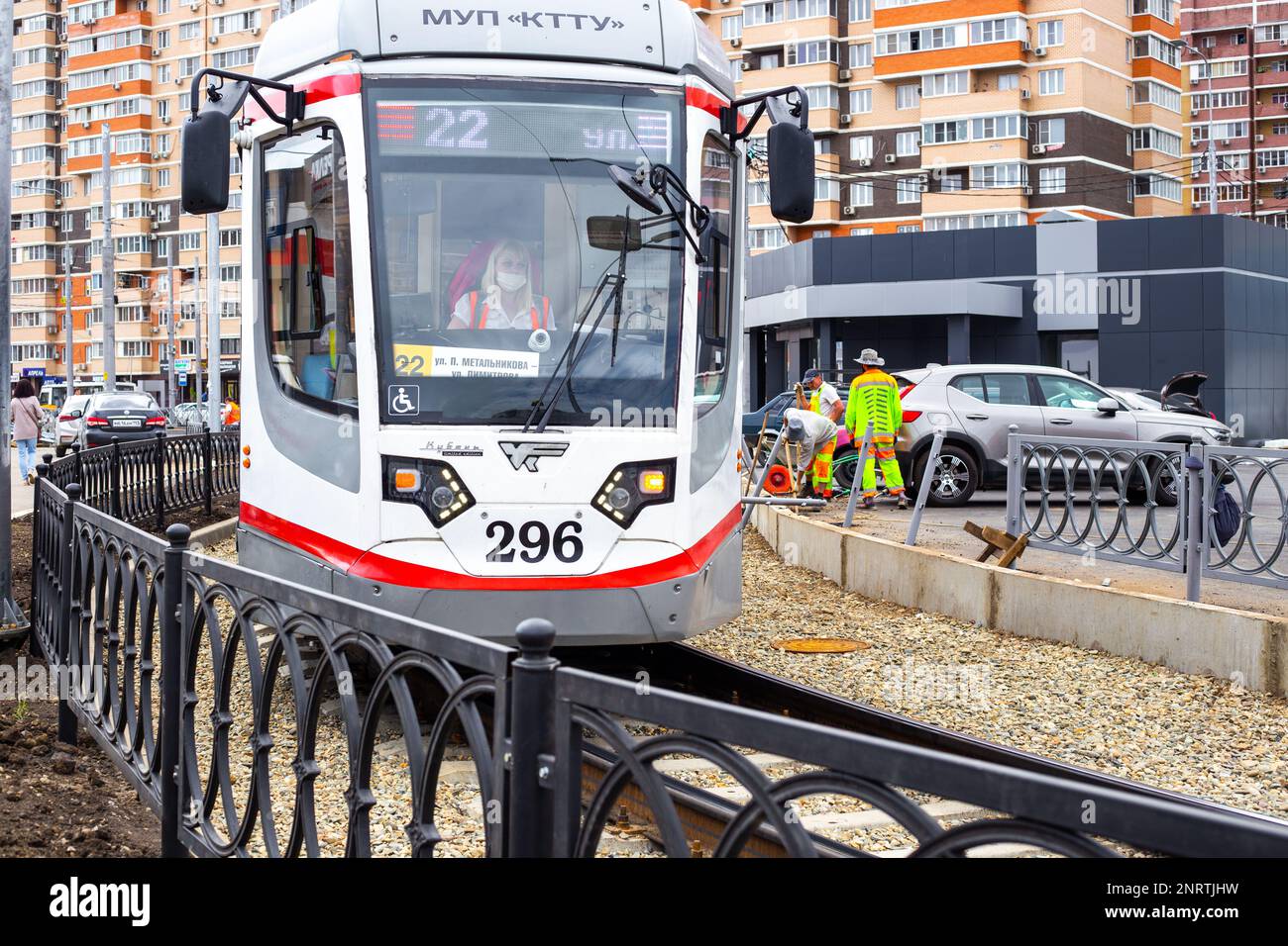 An approaching streetcar with a female driver arrives at the streetcar ...
