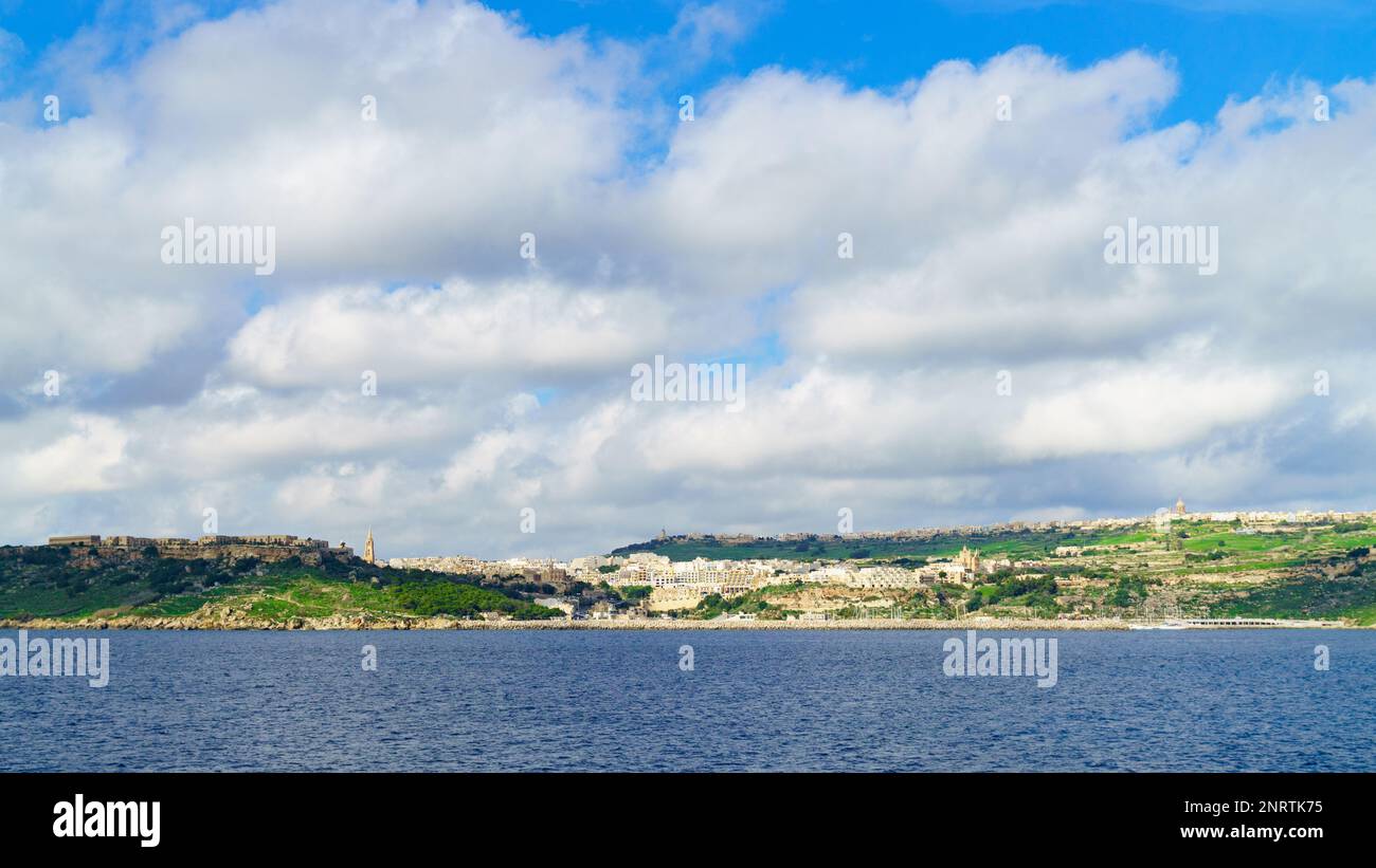 Island Gozo, Malta. Spring time blue cloudy sky, young green grass and ...