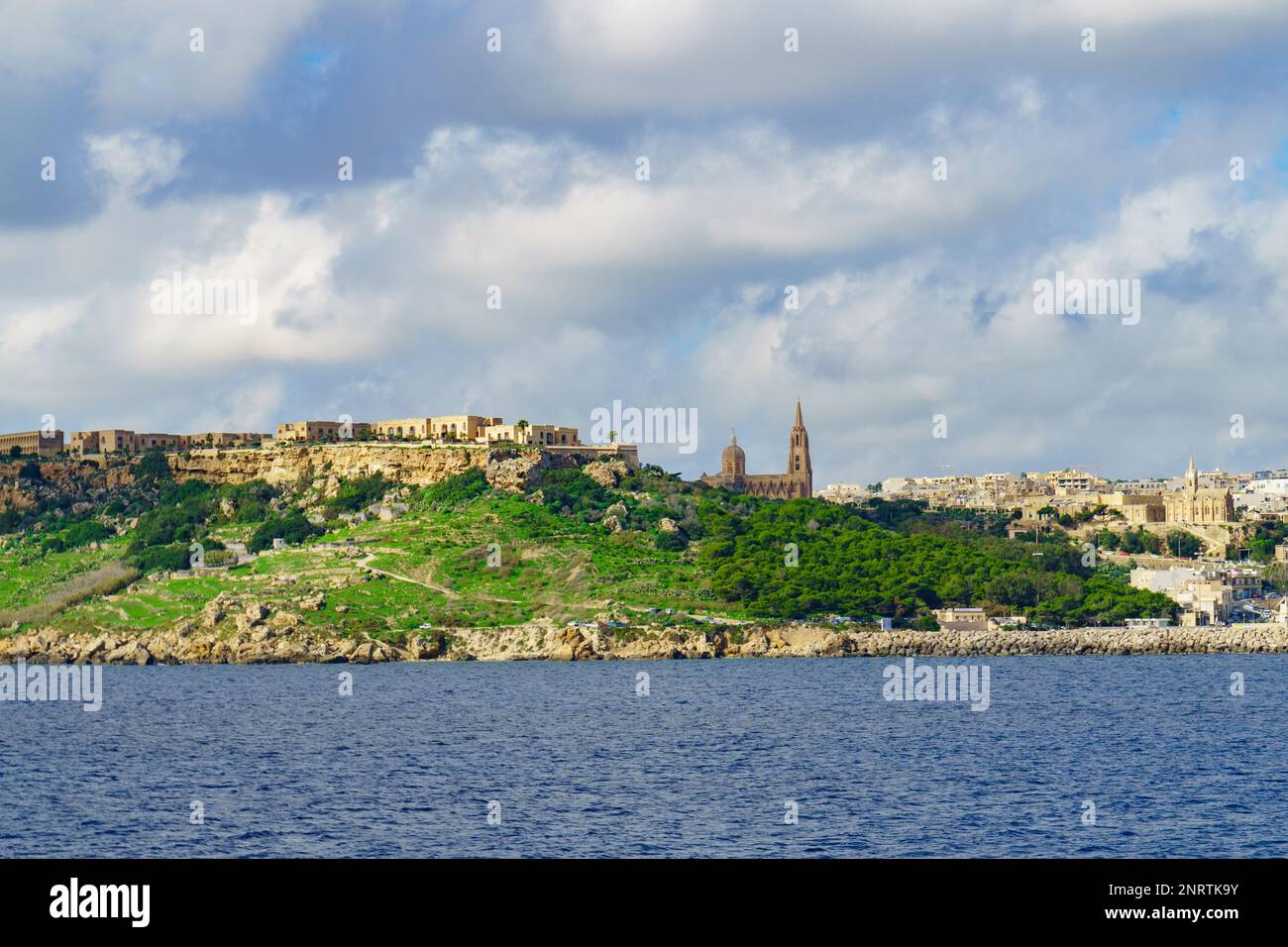 Island Gozo, Malta. Spring time blue cloudy sky, young green grass and ...