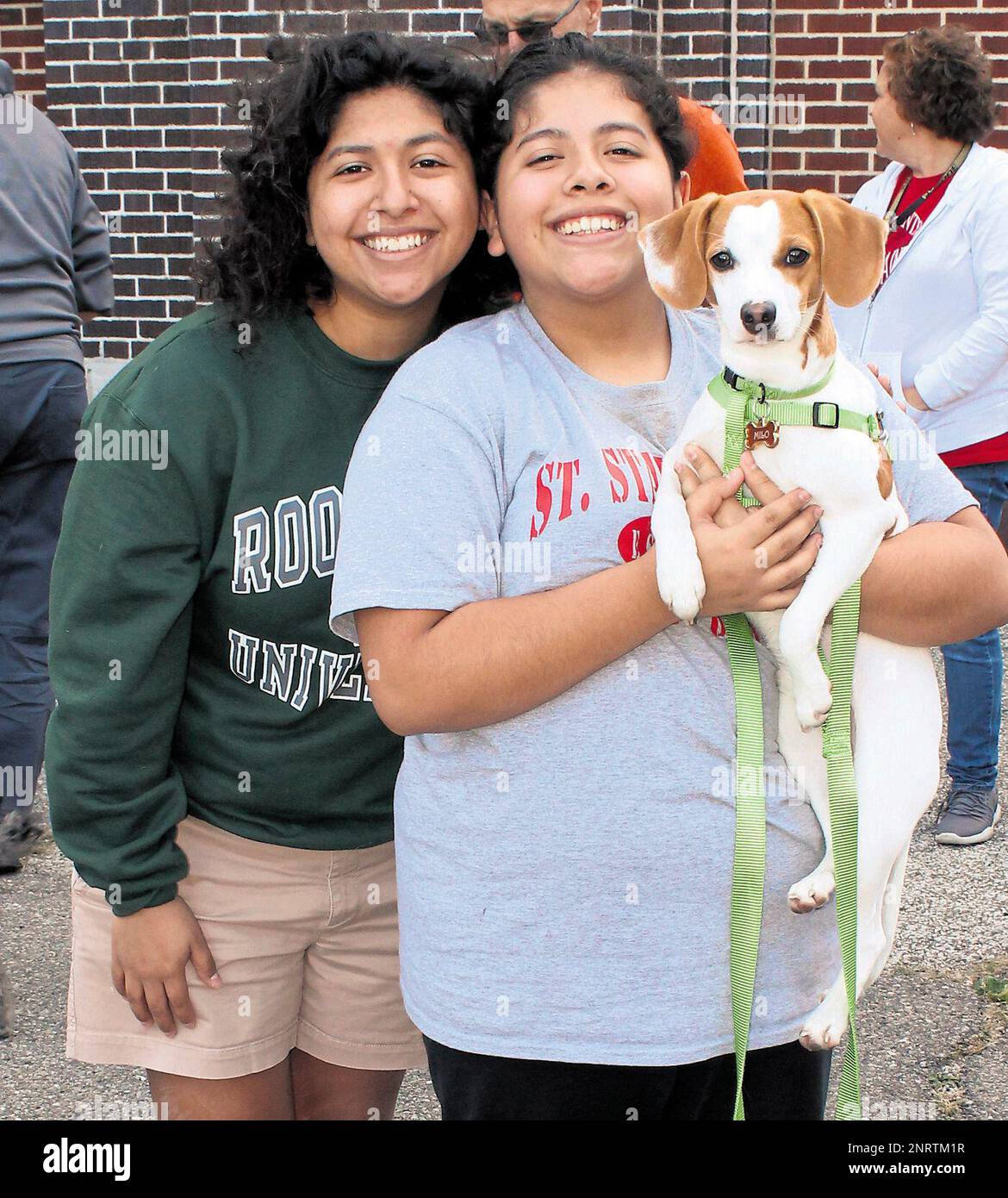 Sisters Leslie and Alexa Reyes are all smiles as they wait in line to ...