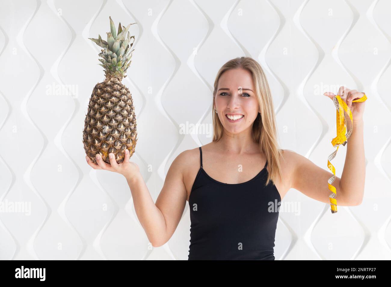 Happy smiling fitness model woman athlete in black sportswear with ...