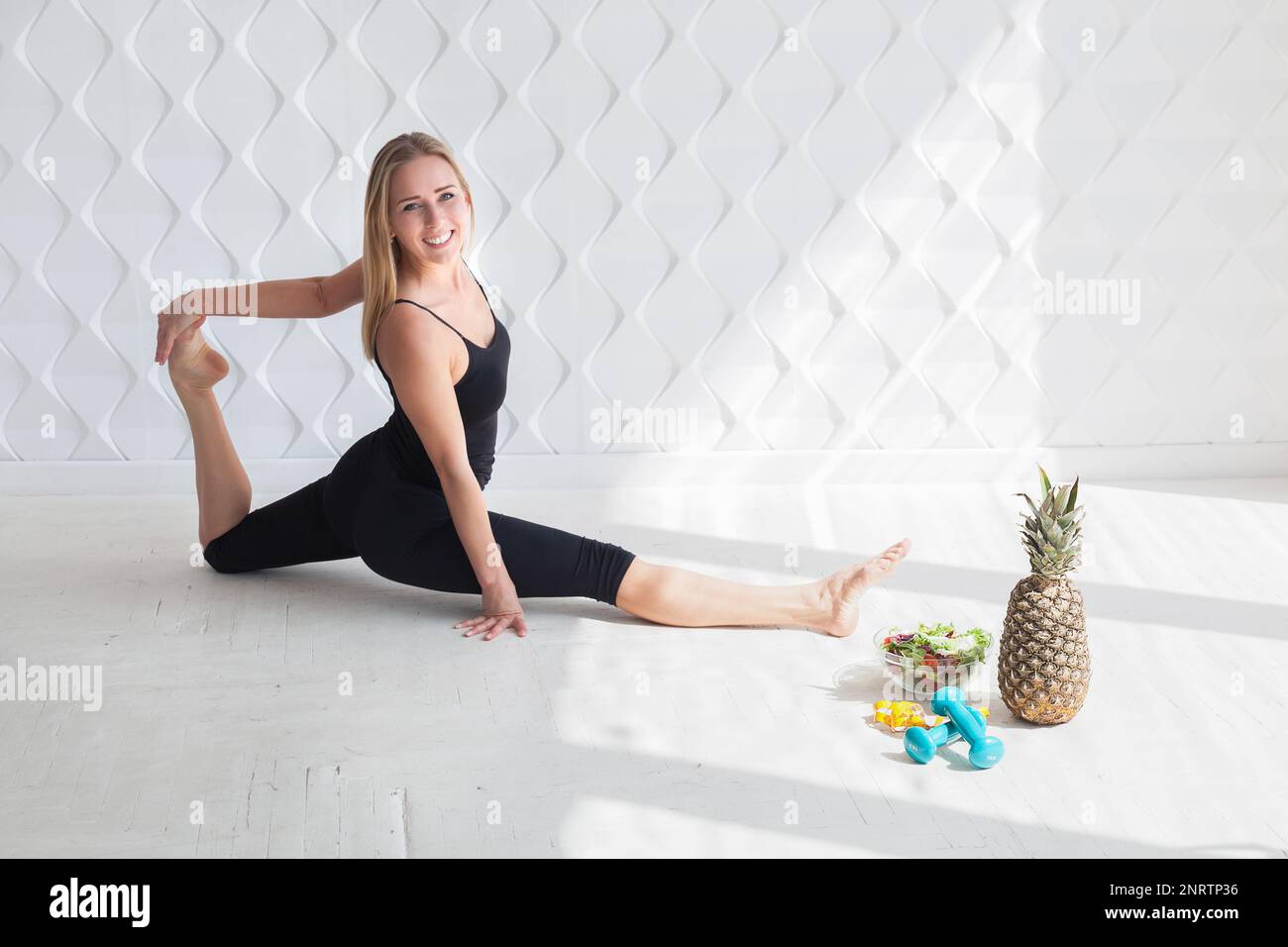 Happy smiling fitness model woman athlete in black sportswear doing ...