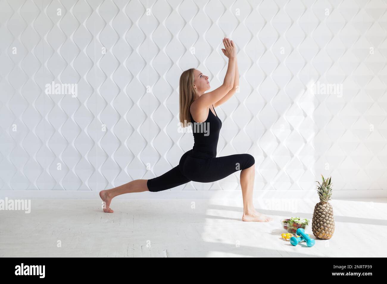 Happy smiling fitness model woman athlete in black sportswear doing ...