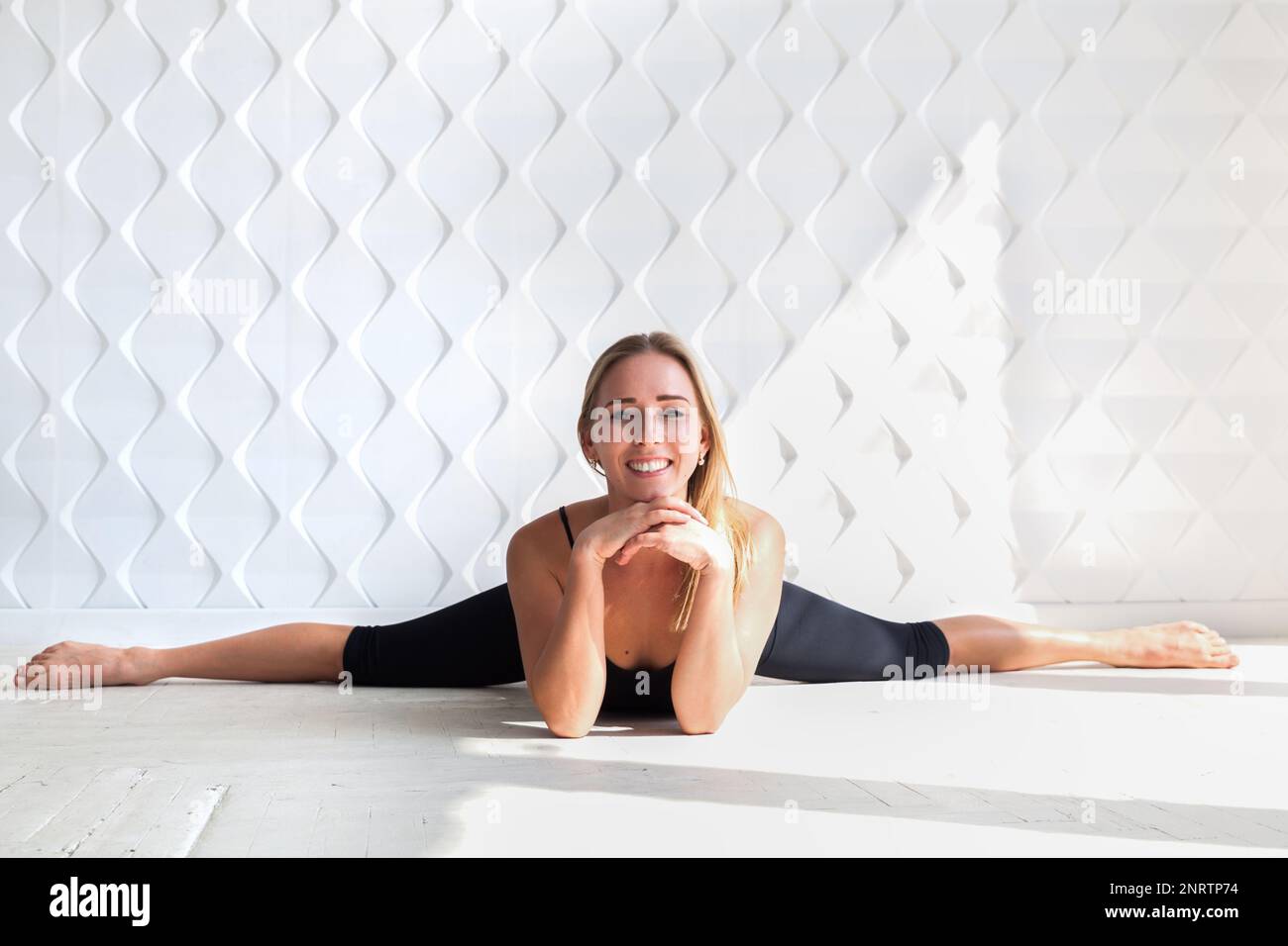 Happy smiling fitness model woman athlete in black sportswear doing ...