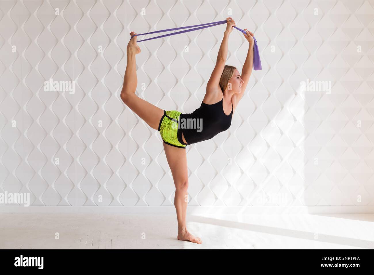 Young happy fitness model woman athlete in sportswear doing stretching ...