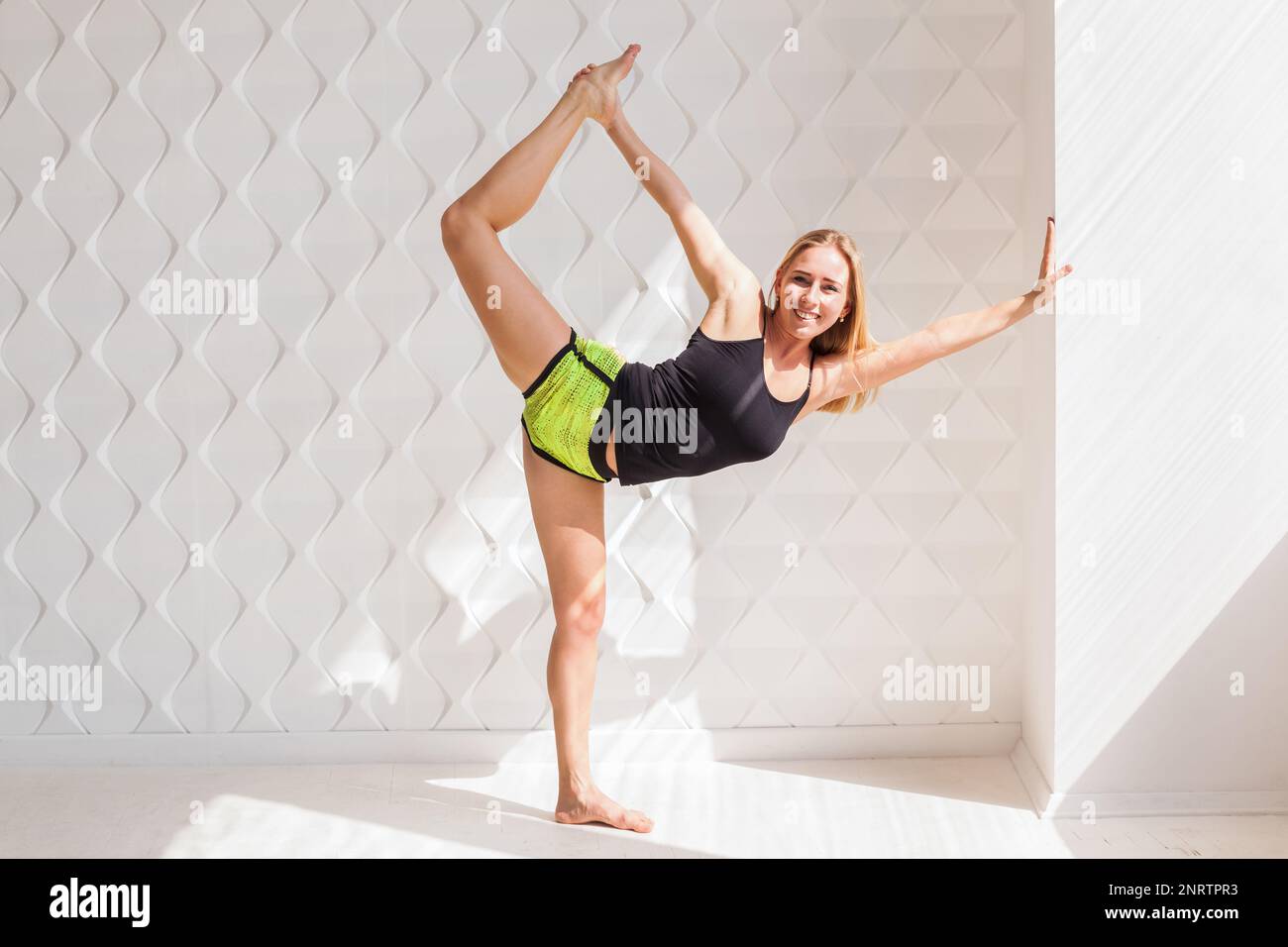 Young happy fitness model woman athlete doing stretching workout near ...