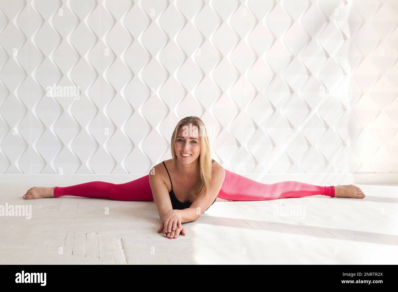 Young adult happy smiling fitness model woman athlete doing workout ...