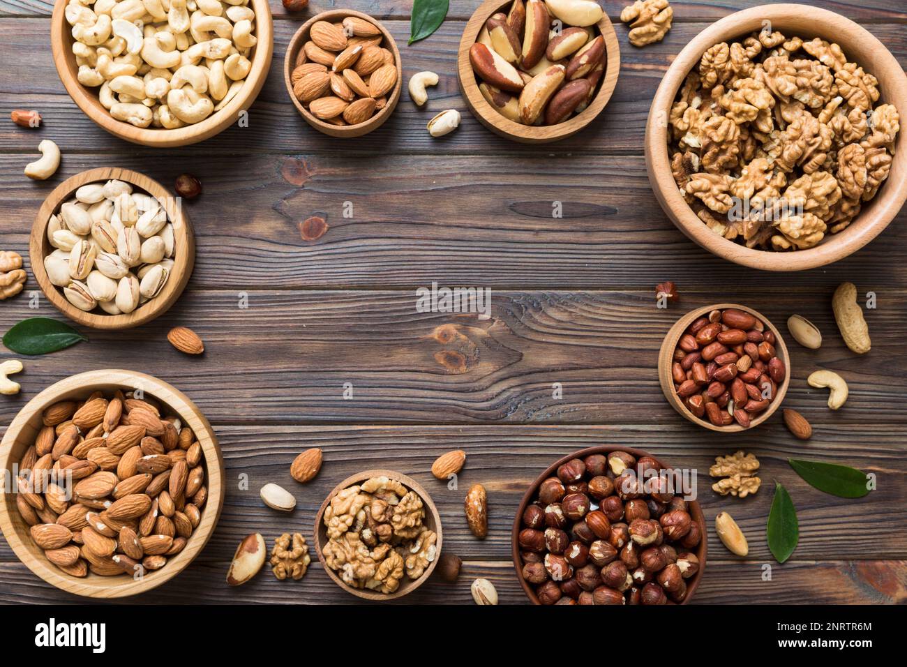 mixed nuts in wooden bowl. Mix of various nuts on colored background ...