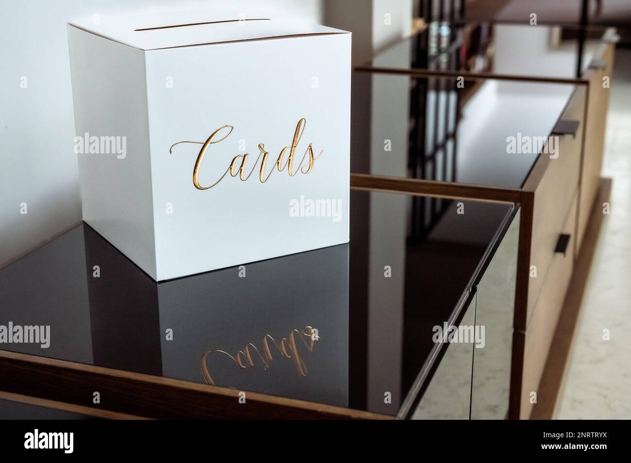 a white box with gold lettering for greeting envelopes standing on a ...