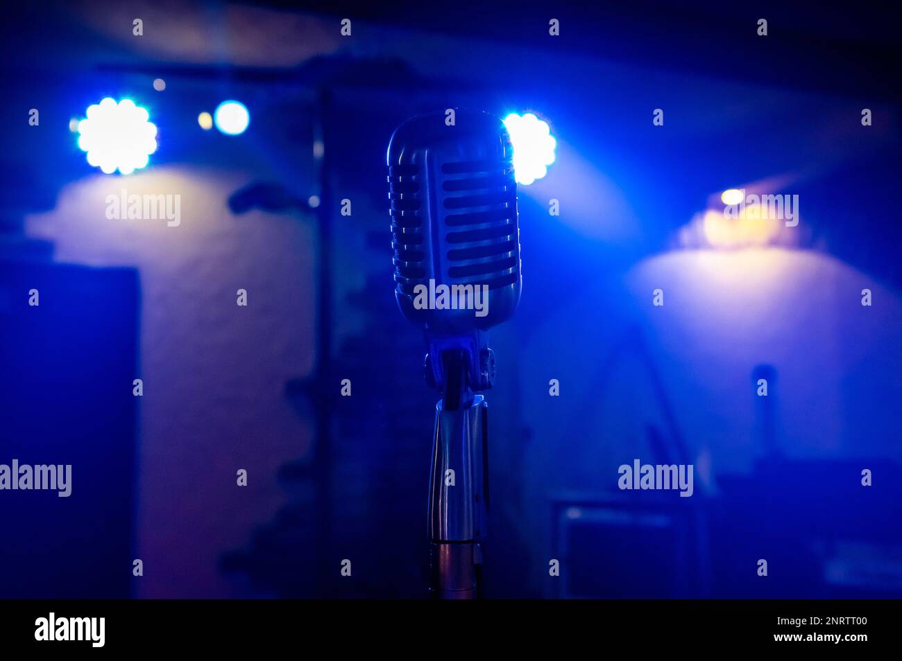 retro style microphone on stage lights background Stock Photo - Alamy