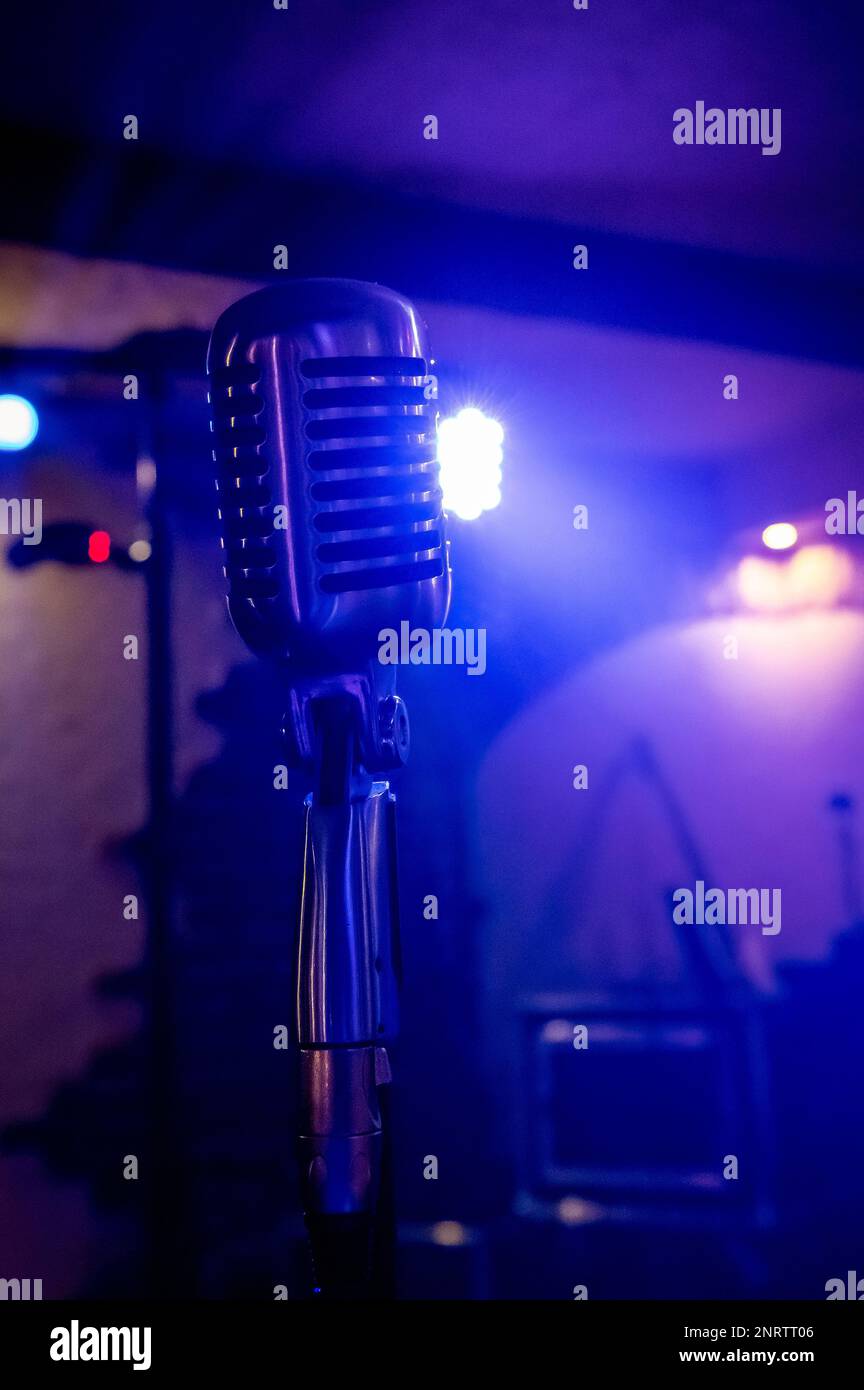 retro style microphone on stage lights background Stock Photo - Alamy
