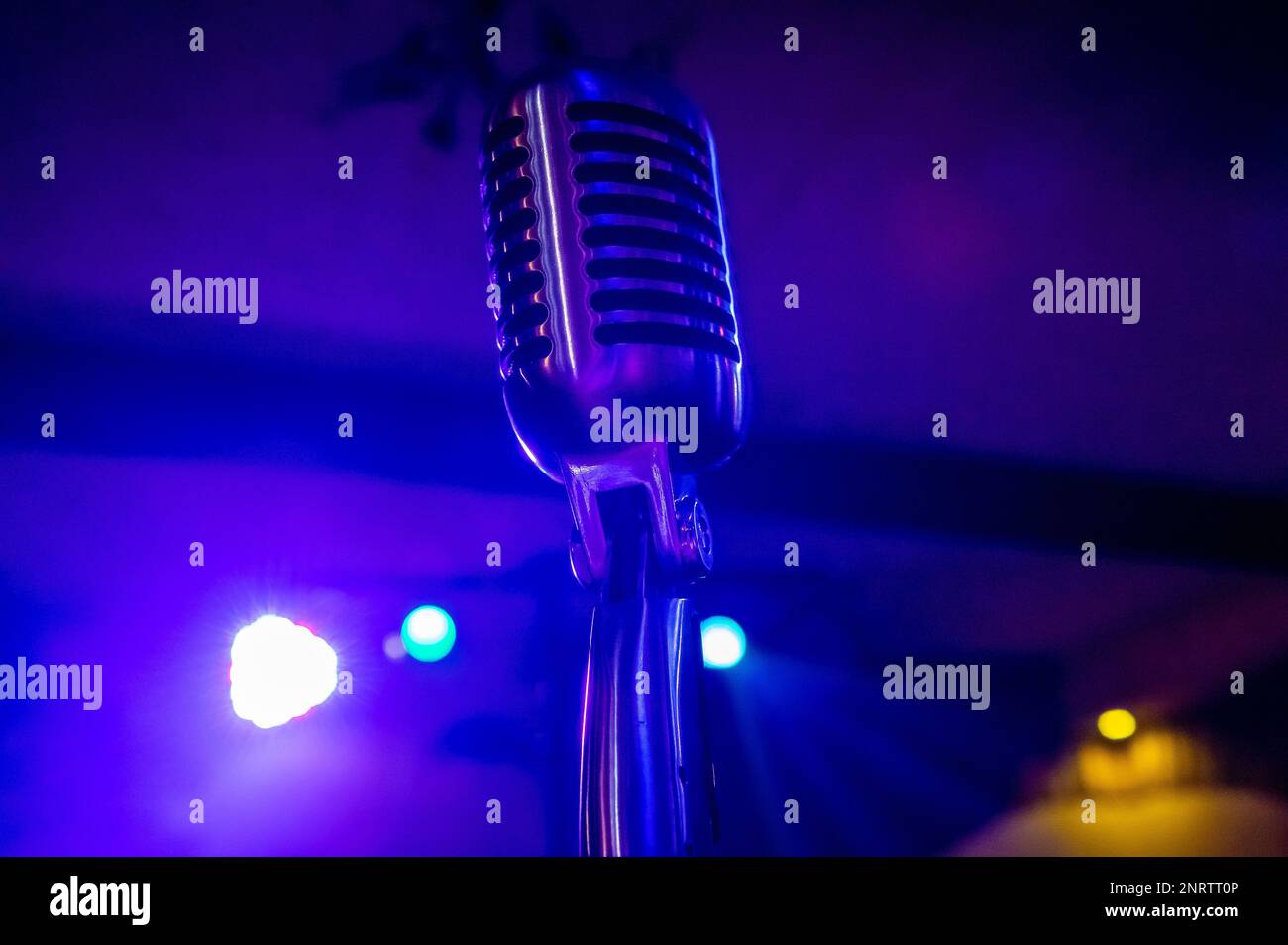 retro style microphone on stage lights background Stock Photo - Alamy